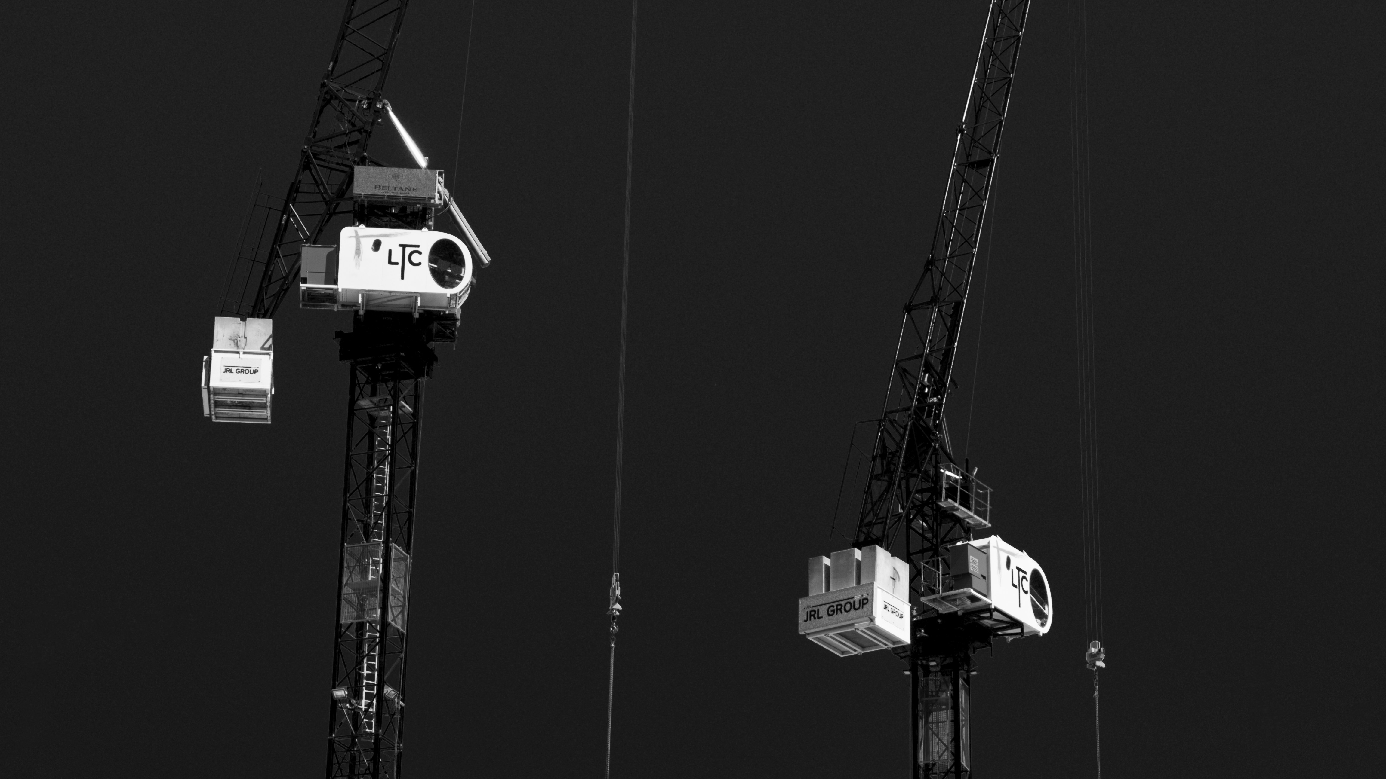 Monoliths of Metal: Dual Crane Giants in Midnight Silence