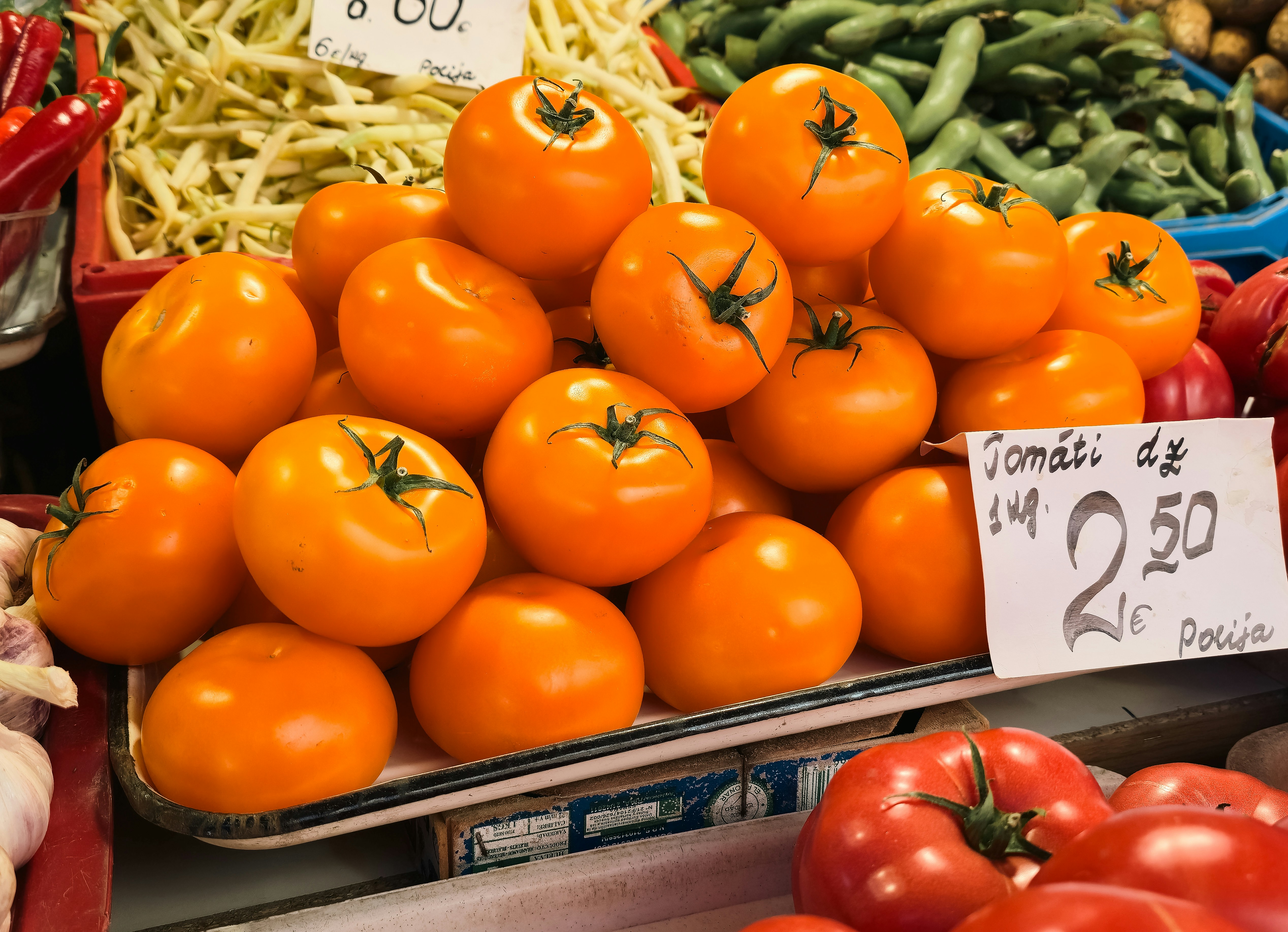 Cascading Orange Orbs: Market Tomatoes at Peak Freshness