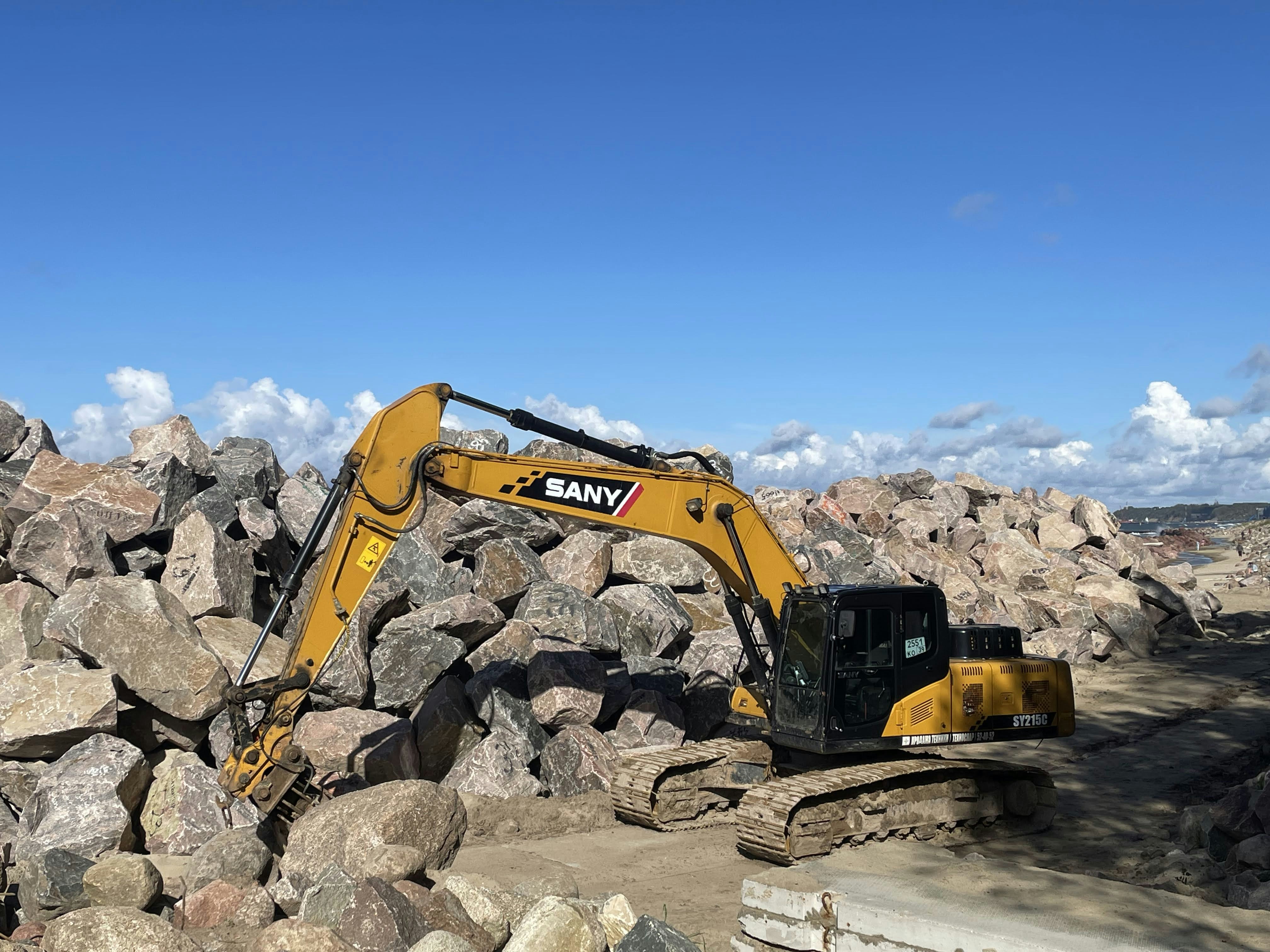 Excavator at the Rock Pile: Machinery in a Coarse Quarry