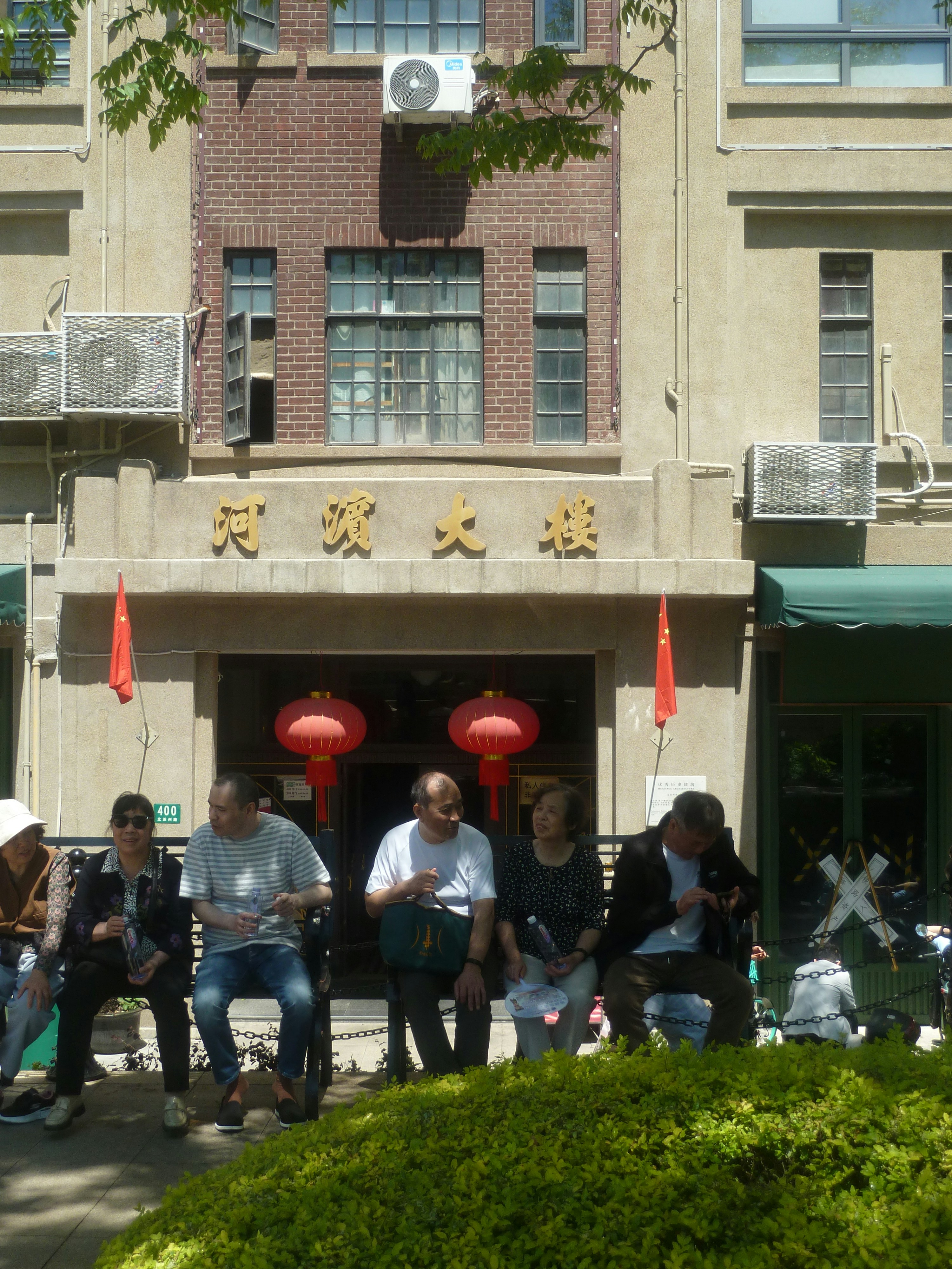 Red Lanterns and City Entrance: A Quiet Moment on a Chinese Street