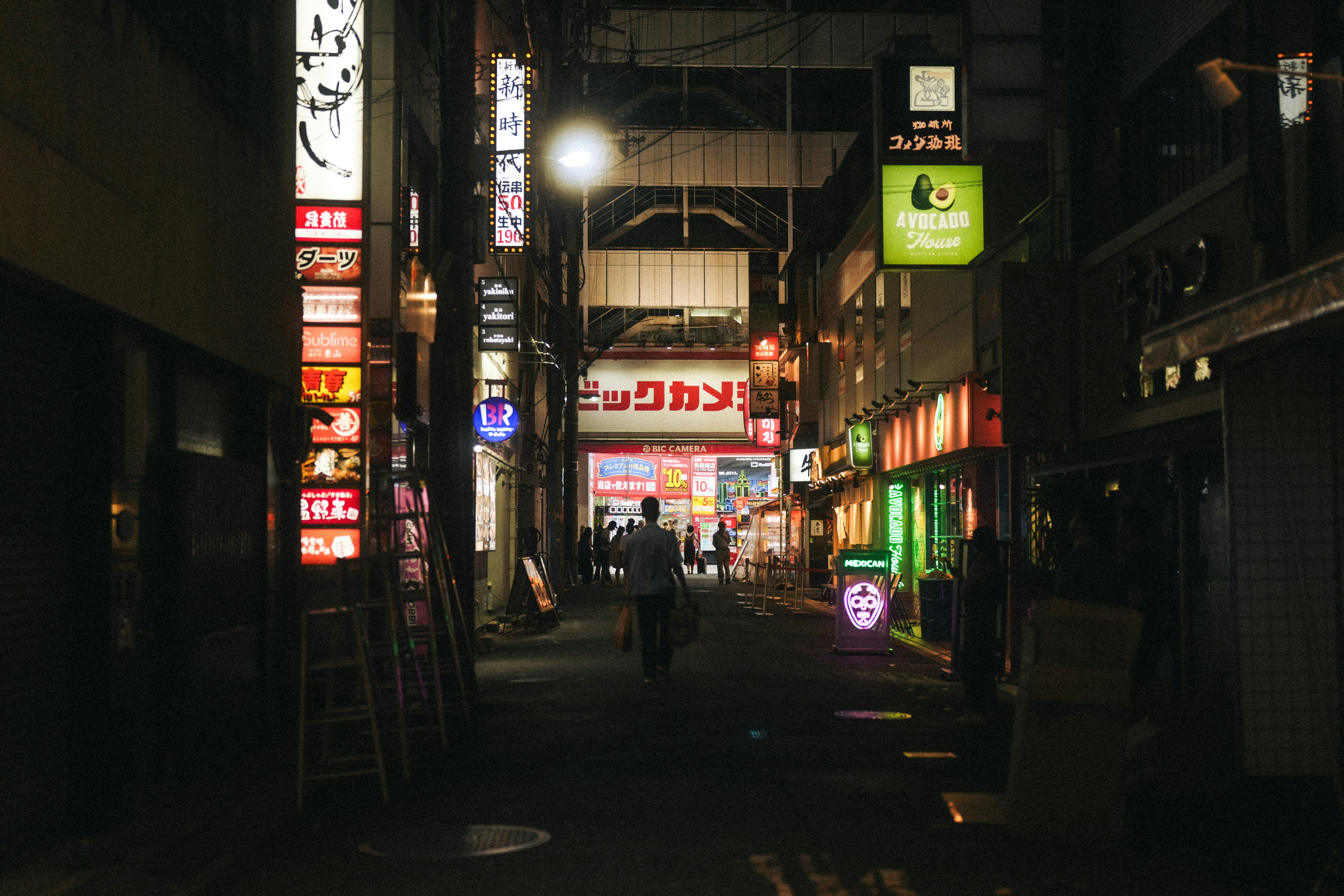 Neon Alley Convergence: A Distant Traveler Beneath Electric Skies
