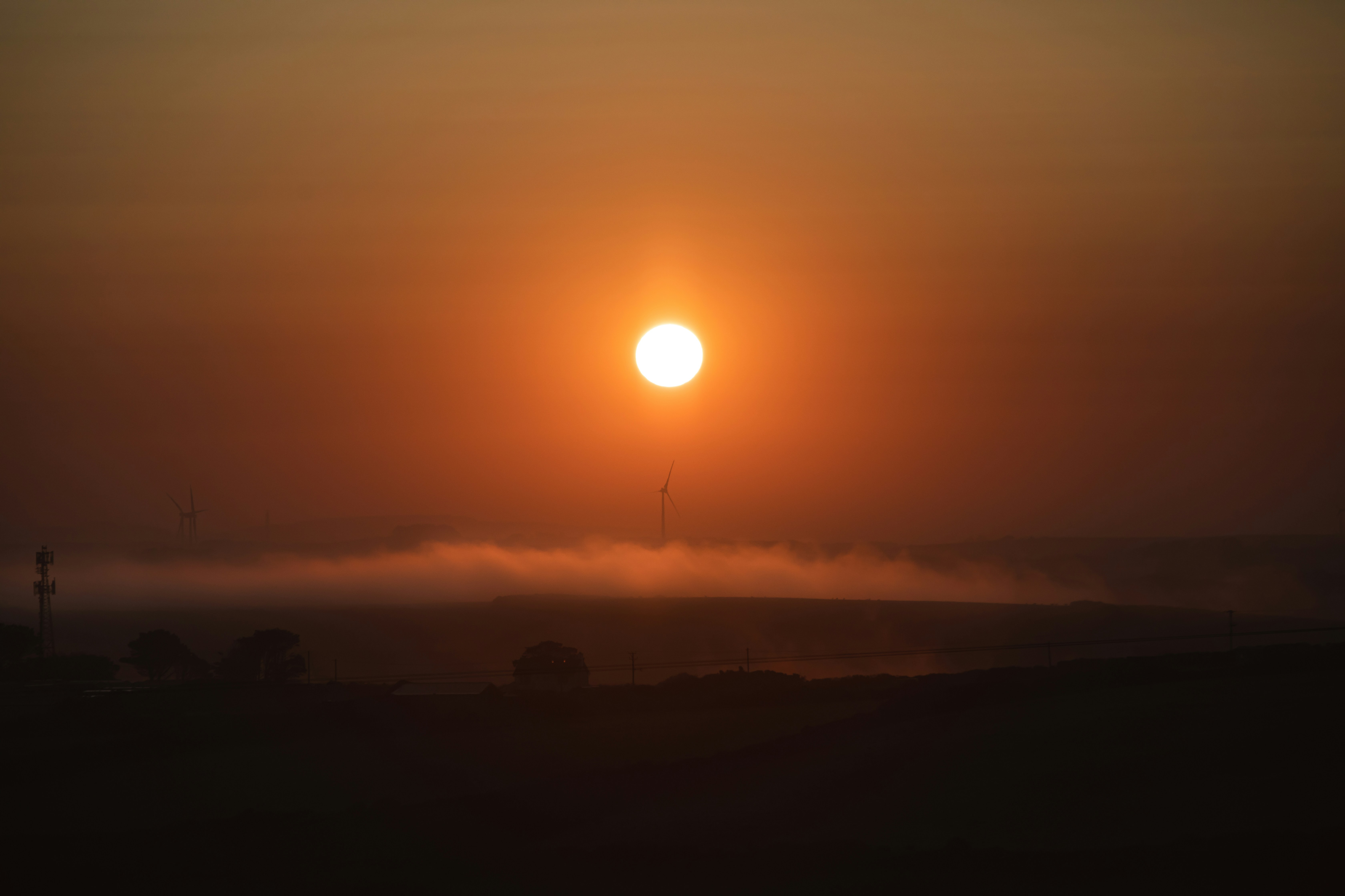 Solitary Sun Over Mist-Kissed Horizon