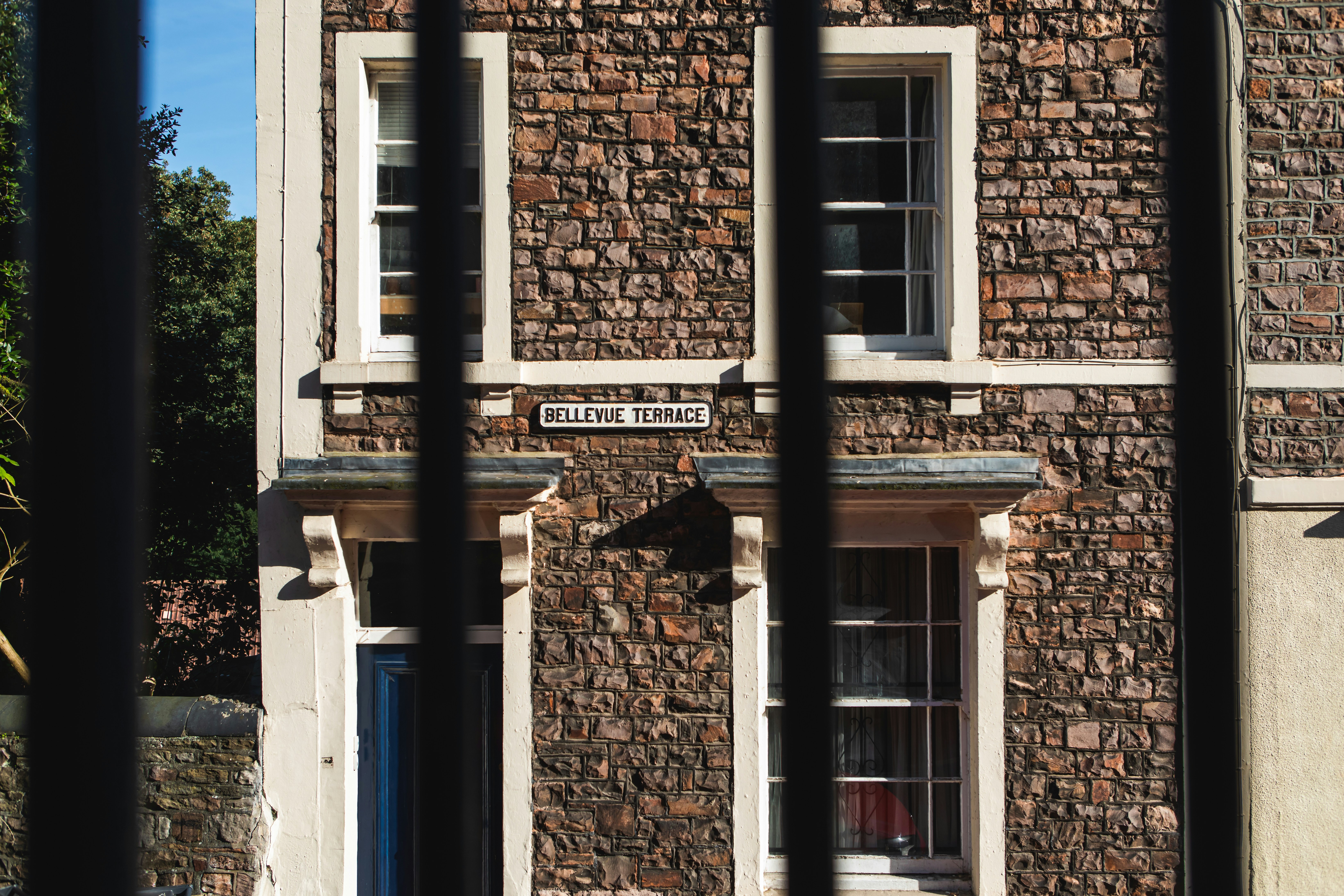 Stark Brick Facade Framed by Iron Bars