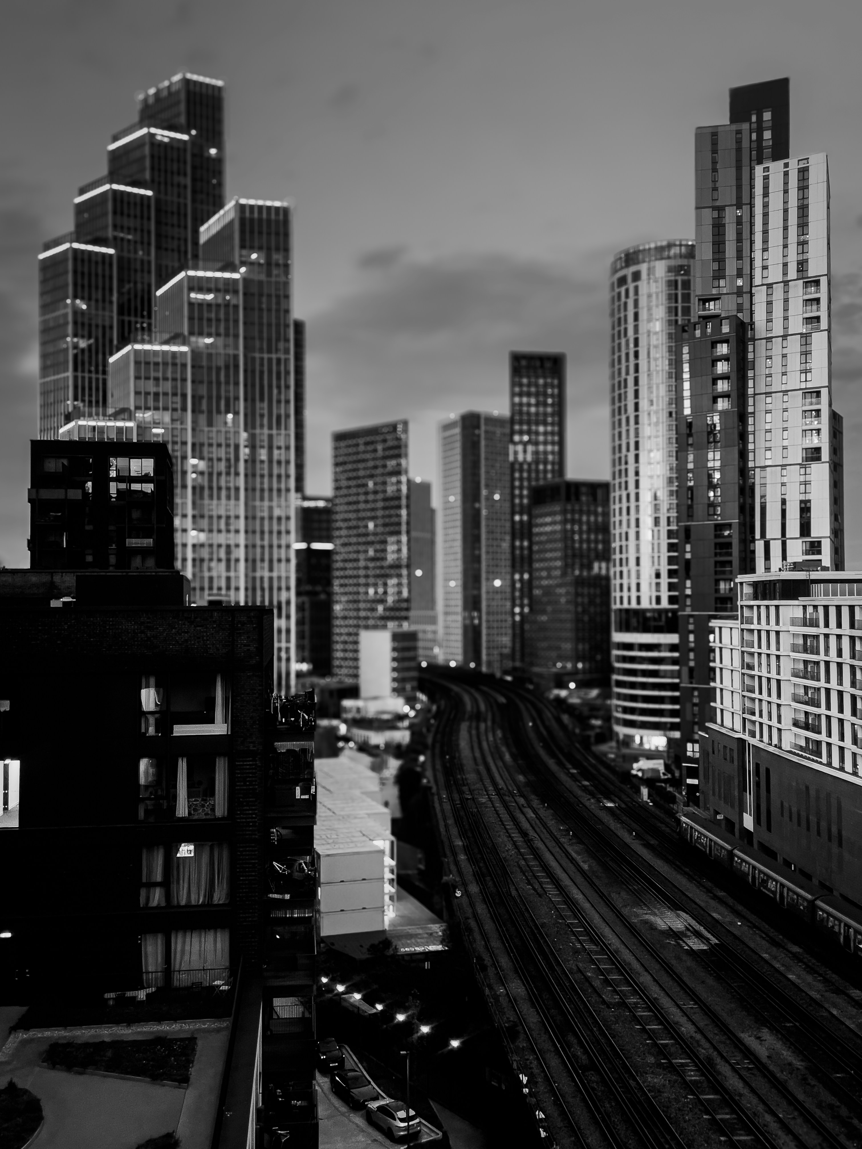 Urban Convergence: Rails Through a Monochrome Skyline