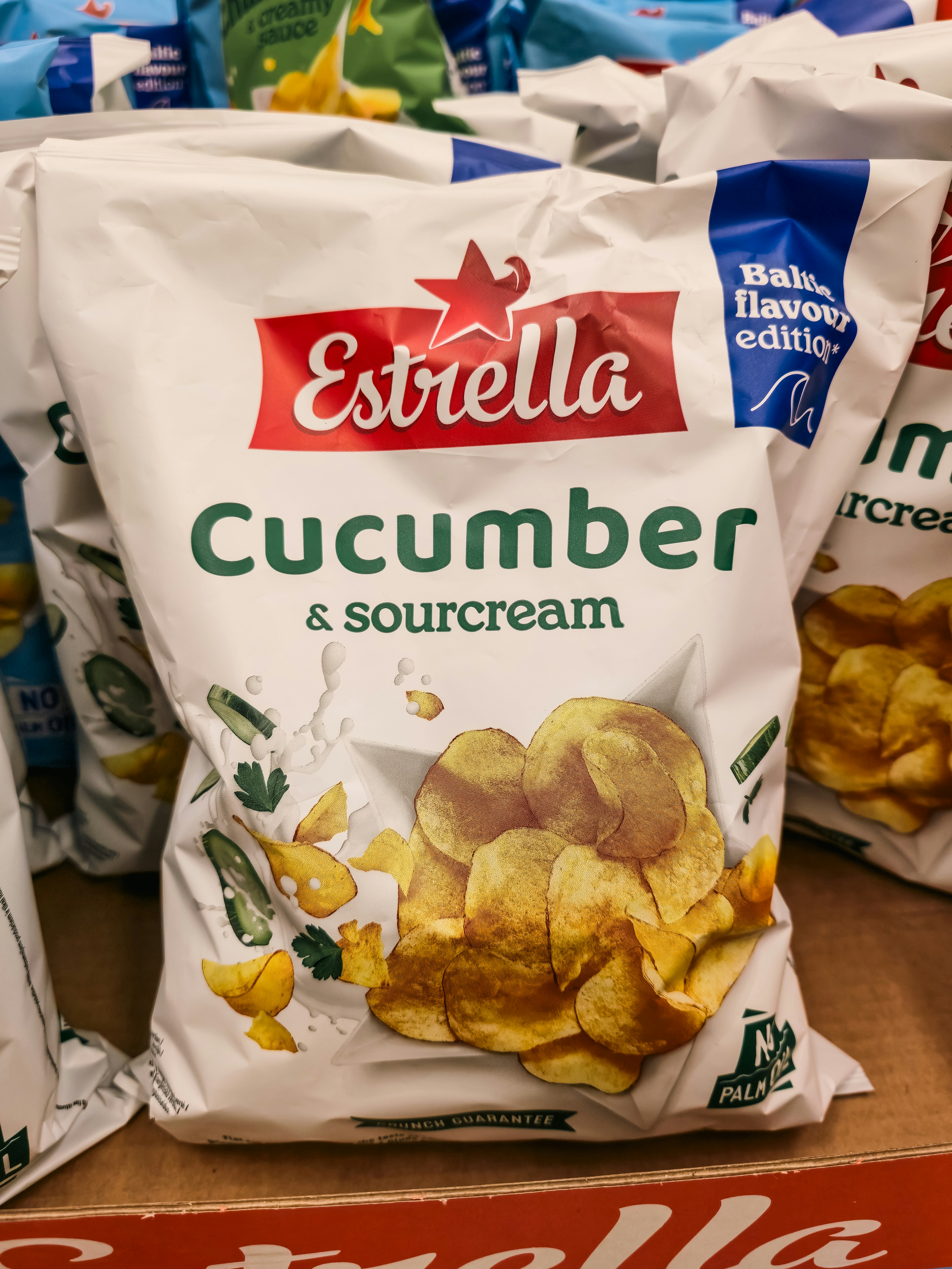 Estrella Cucumber Chips: Crisp Close-Up Amidst a Shelf of Flavor