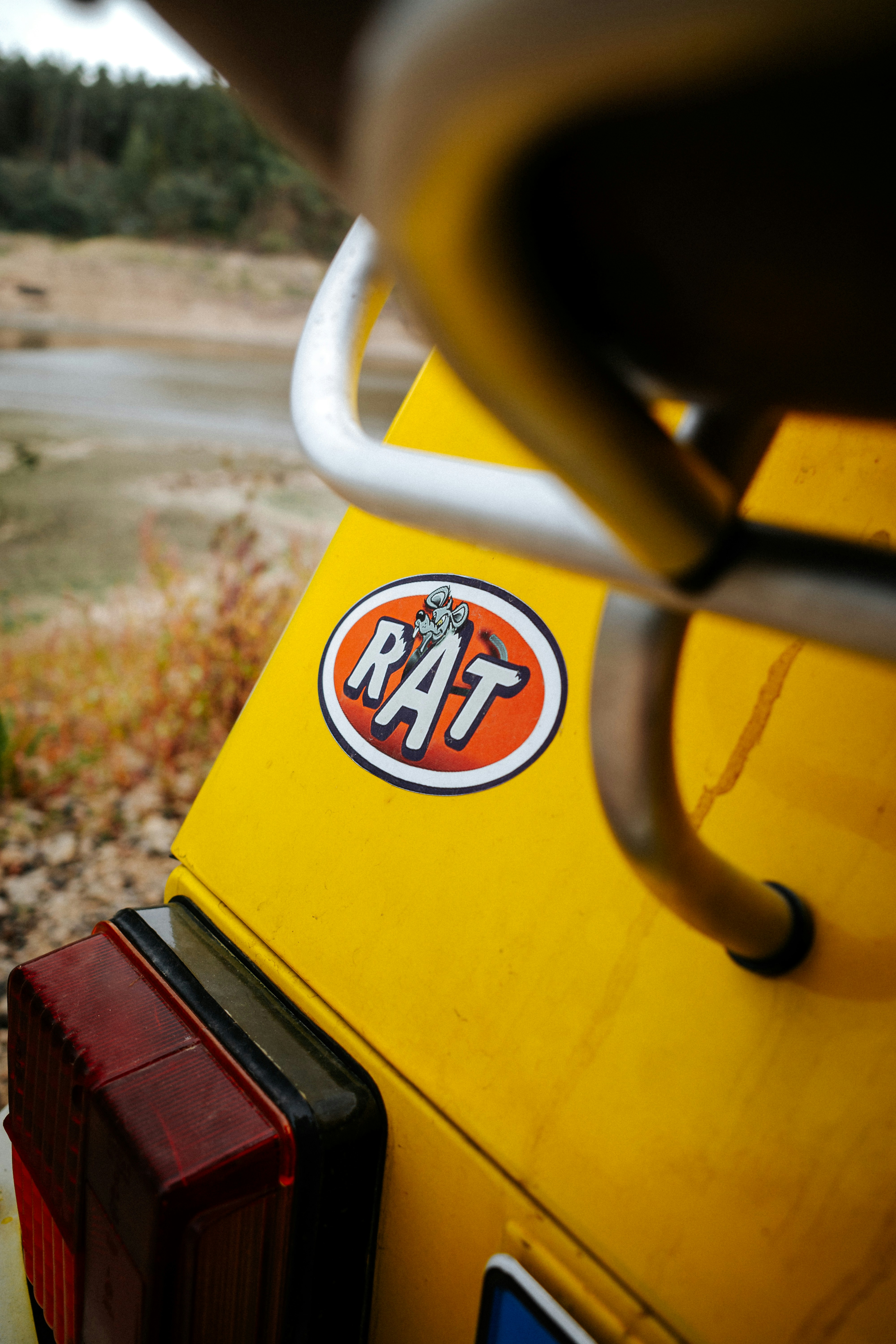 RAT Sticker on a Yellow Vehicle (Close-Up of Emblem) with Tape and Handle Framing