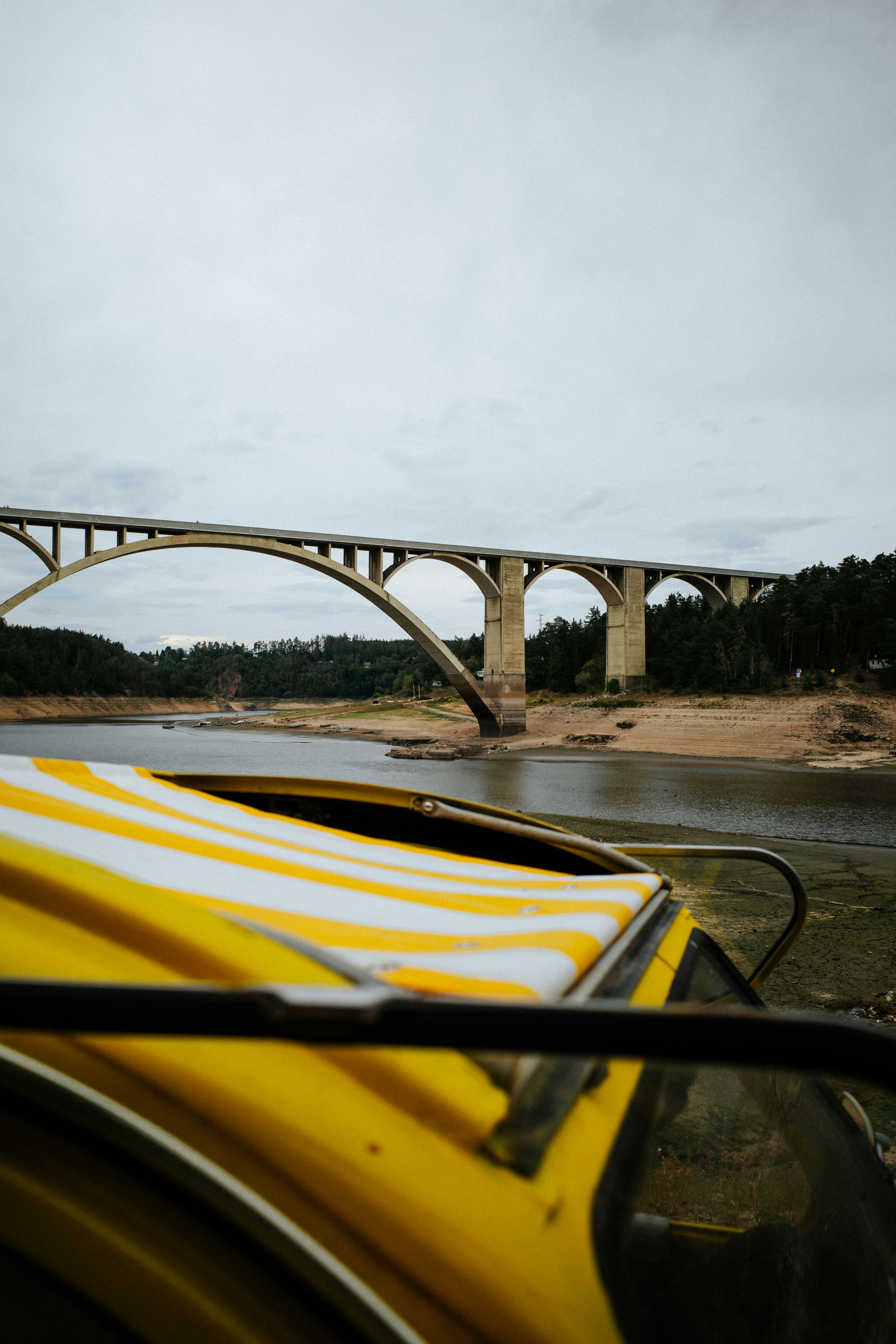 Yellow Boat Vignette: A Long Bridge Over a Quiet River