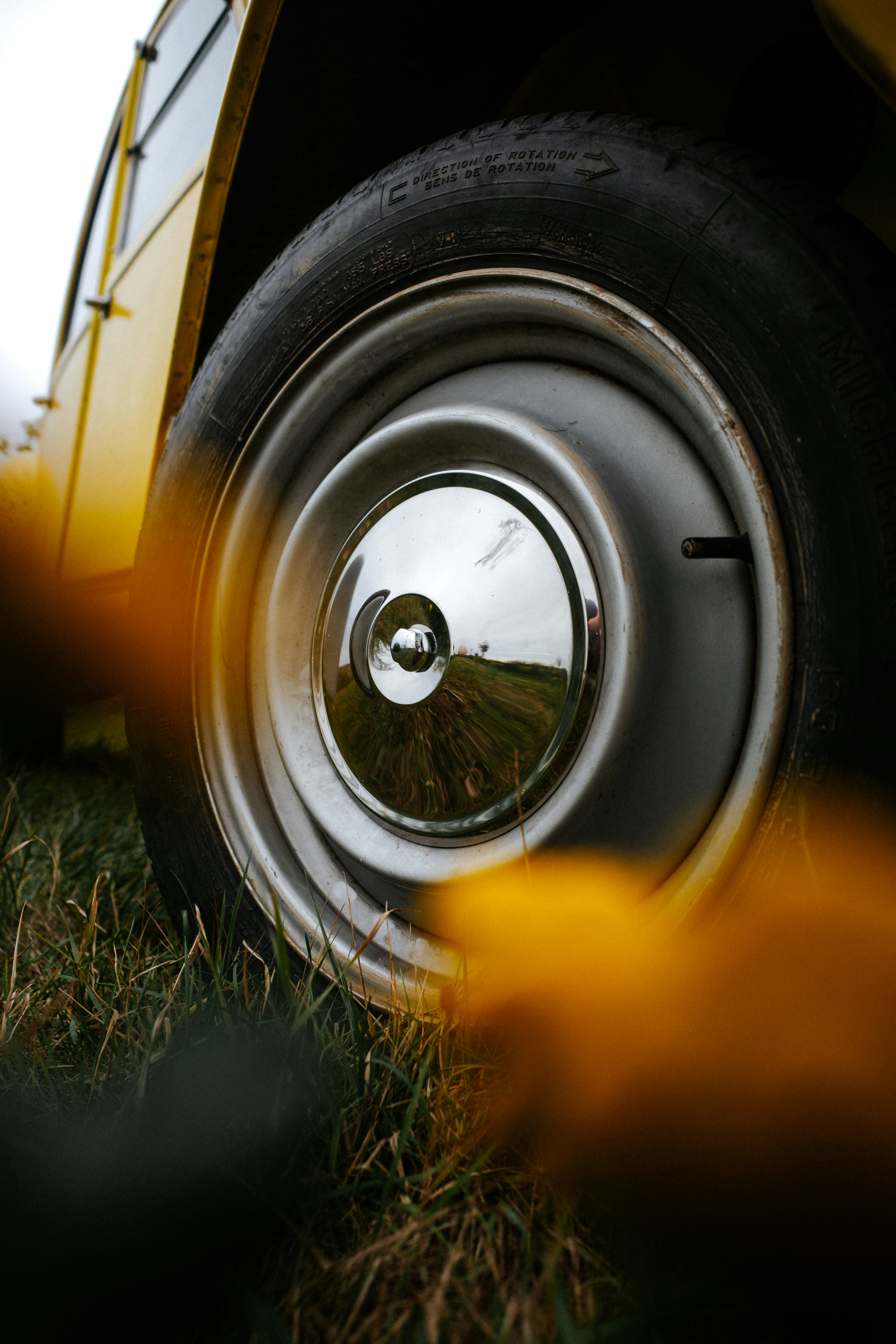 Wheel Reflections: A Quiet Moment Under the Bus