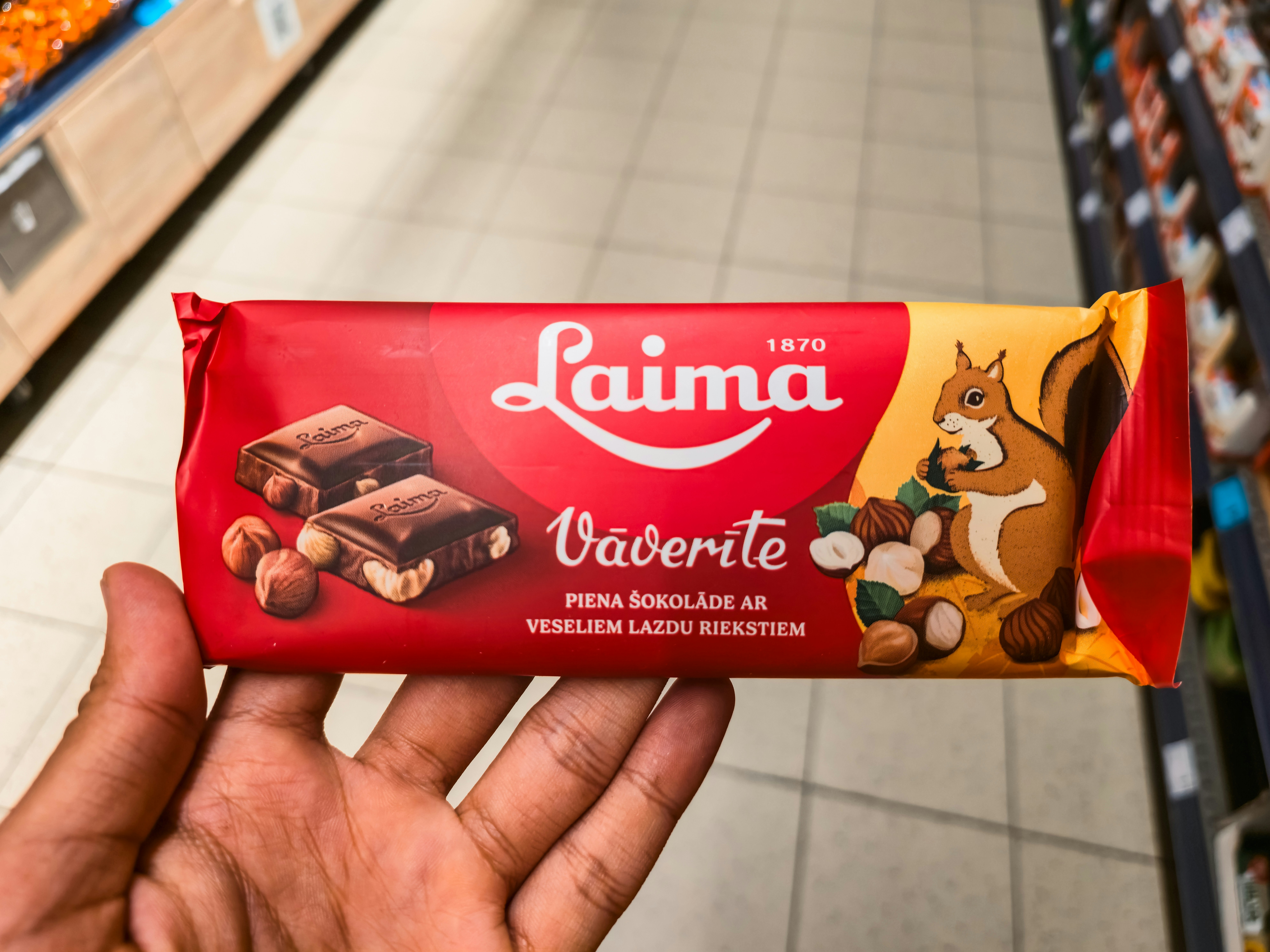 Laima Viens chocolate bar in a shopper’s hand