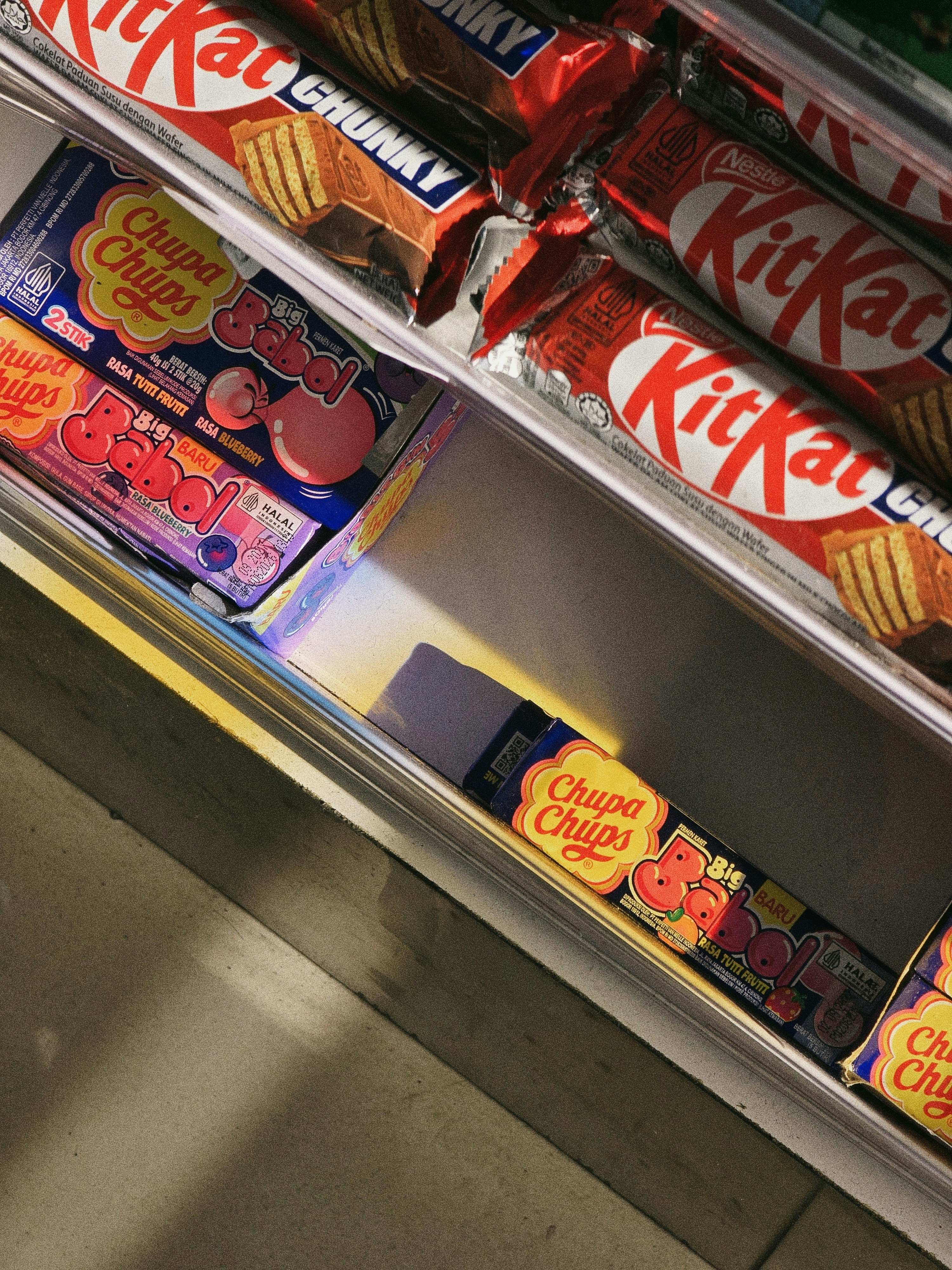 Candy Aisle Tilt: KitKat Rows in Colorful Street Shelf