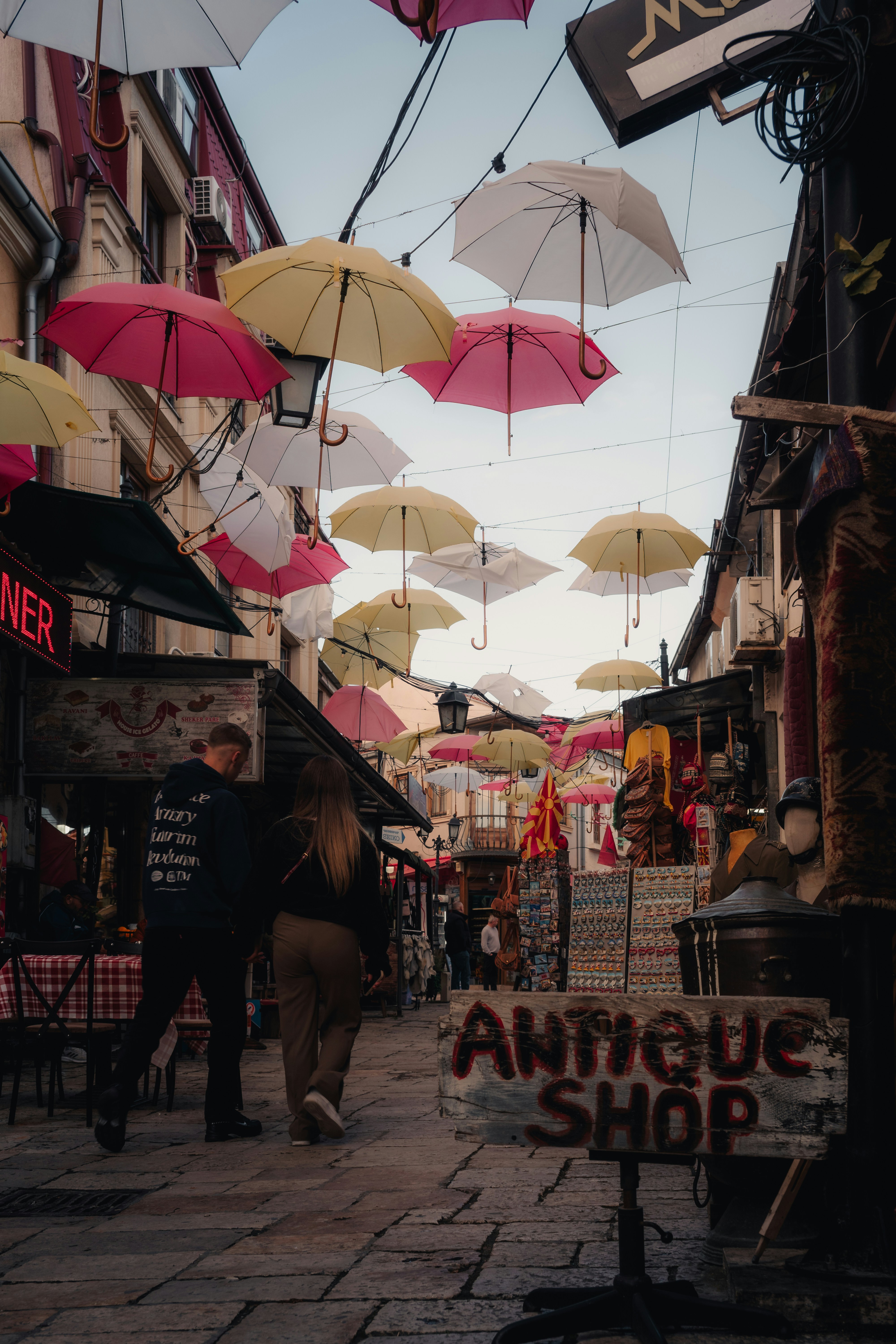 Umbrella Arc Over a Quiet Street Market