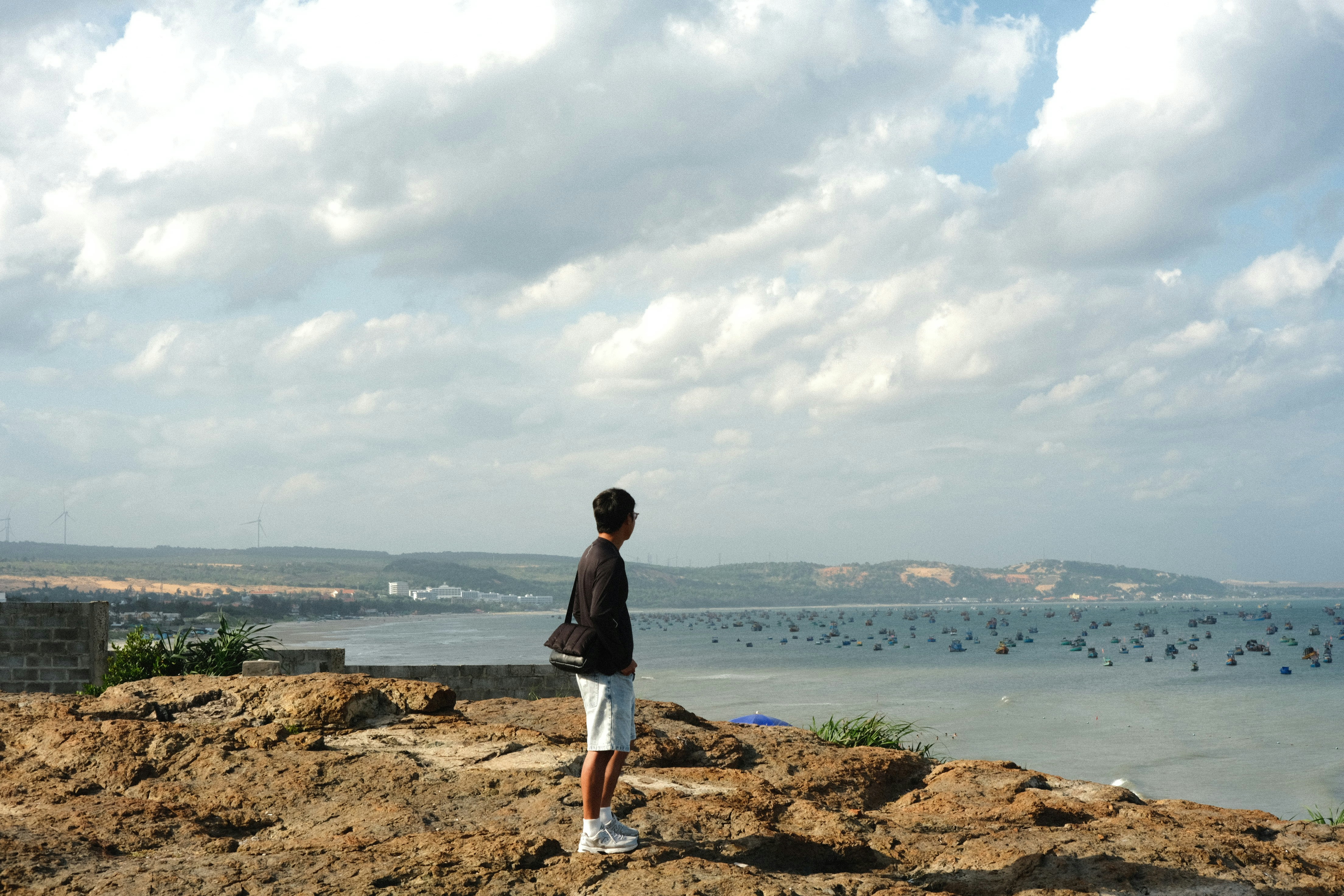 Coastline Gazer: A lone figure on rugged shores
