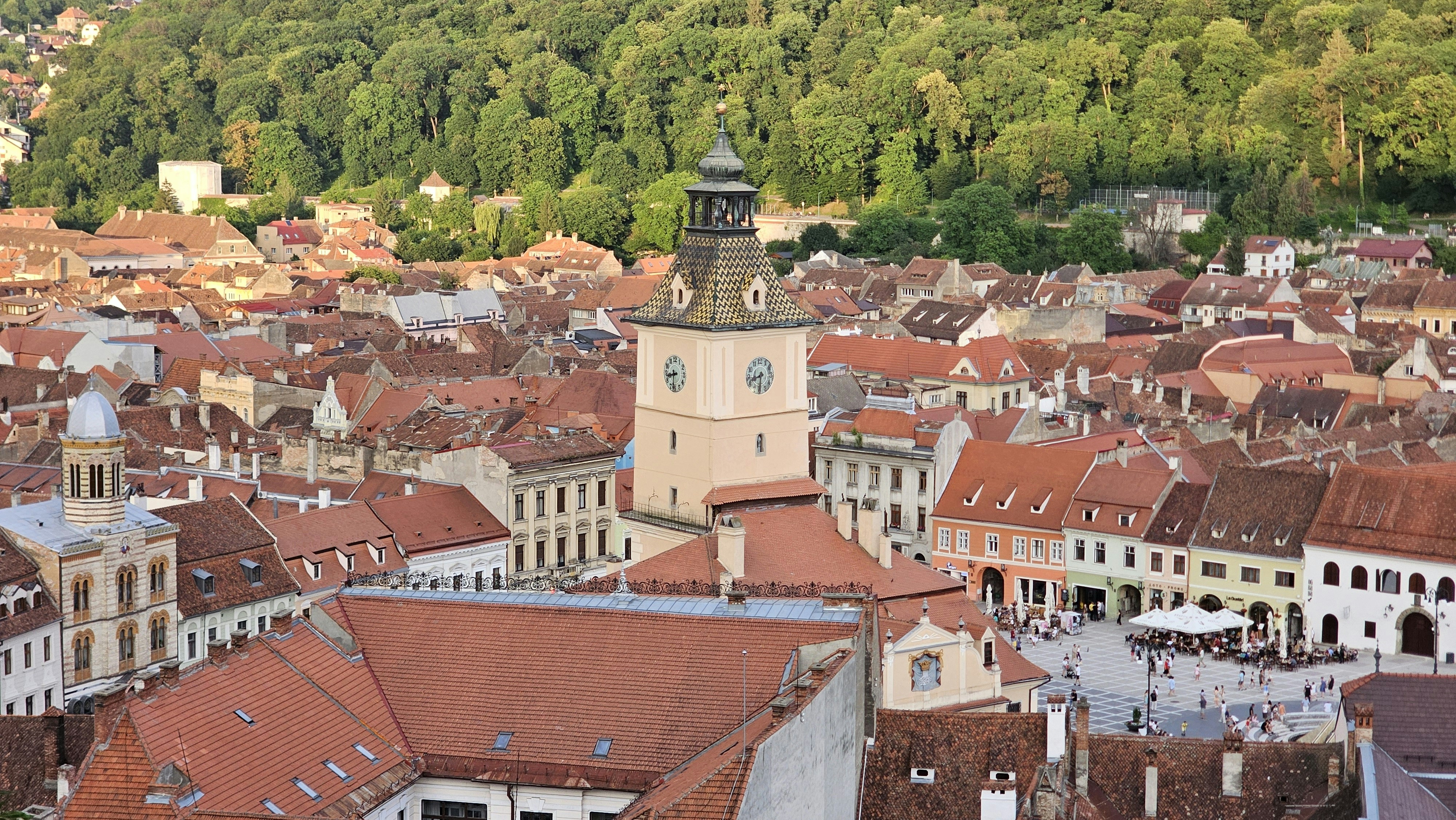 The Black Church tower rising above the red tiled roofs of Brasov, Romania