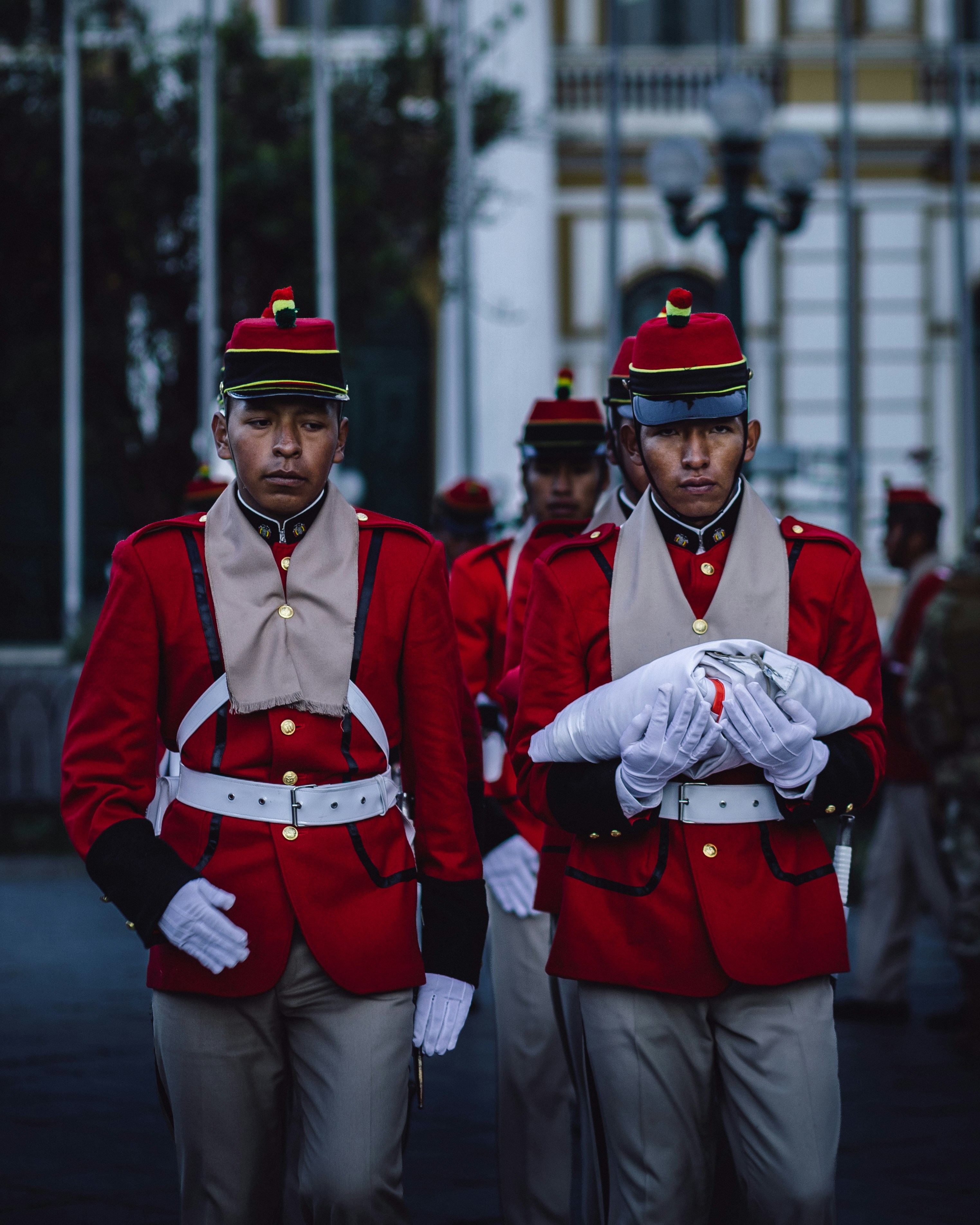 Red Uniforms, Quiet March: Guards at a Historic Courtyard