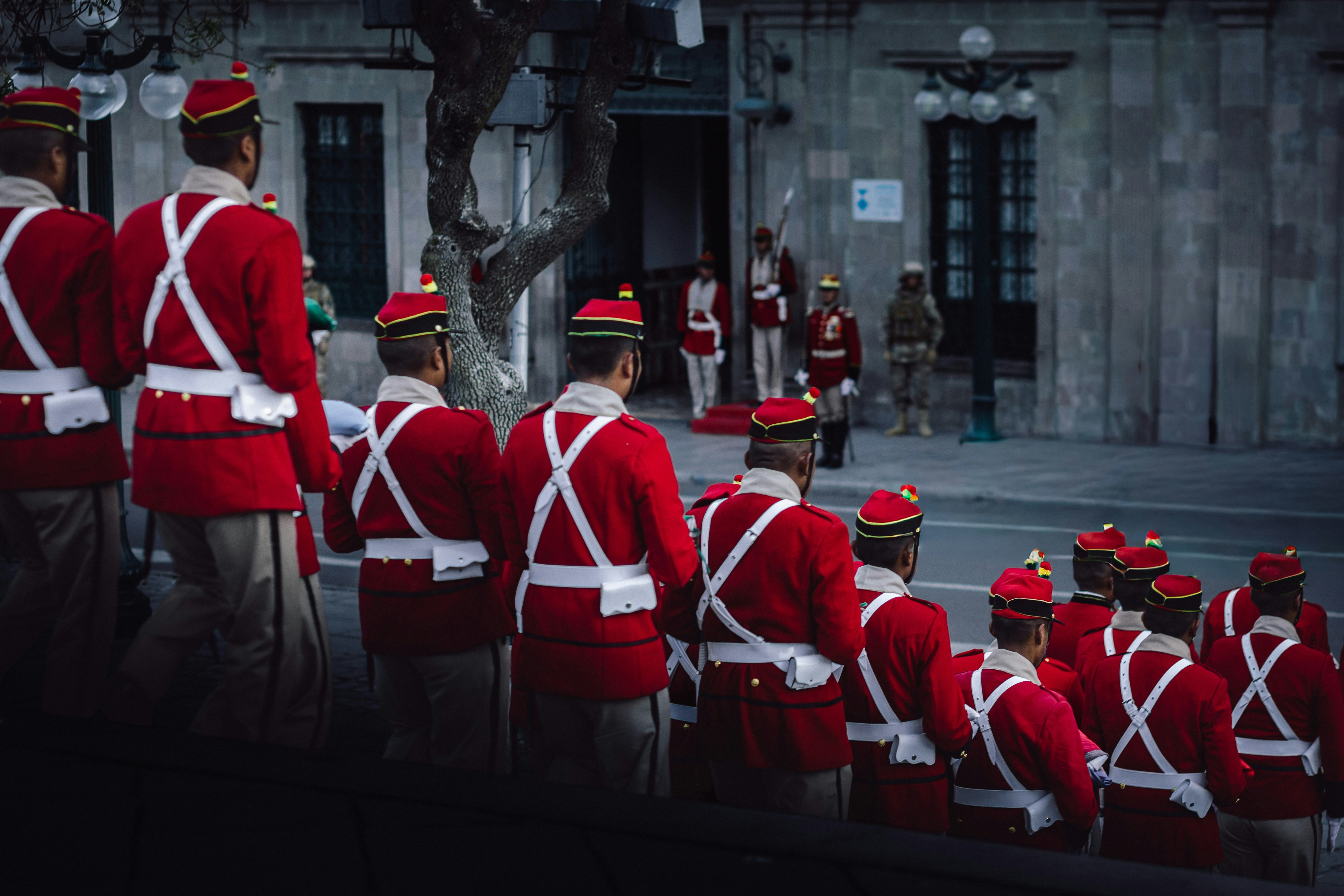Red-Uniform Row: Guard Details in an Urban Courtyard