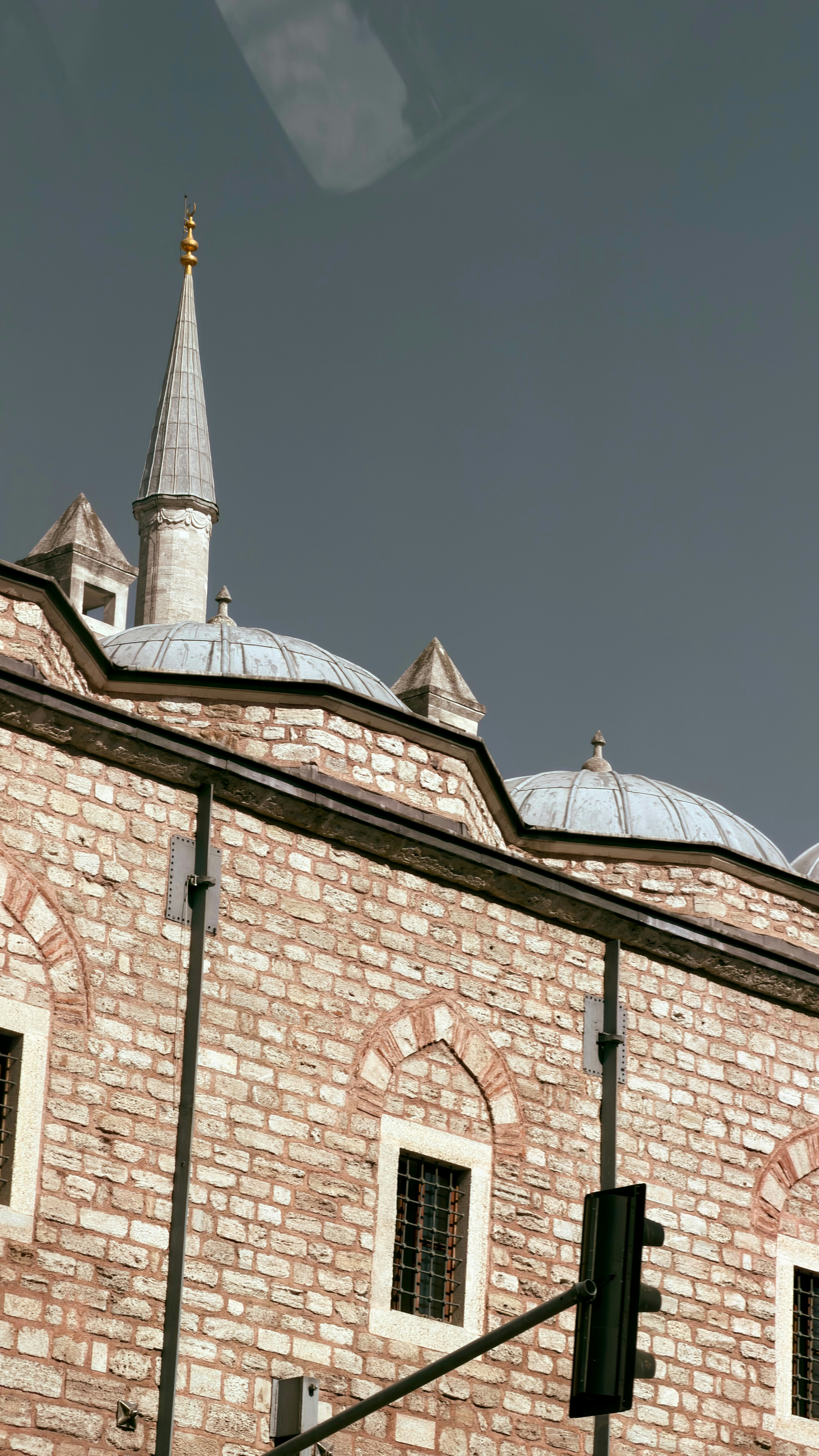 Brick Cathedral: A Tilted View of Arched Windows and Domed Rooflines