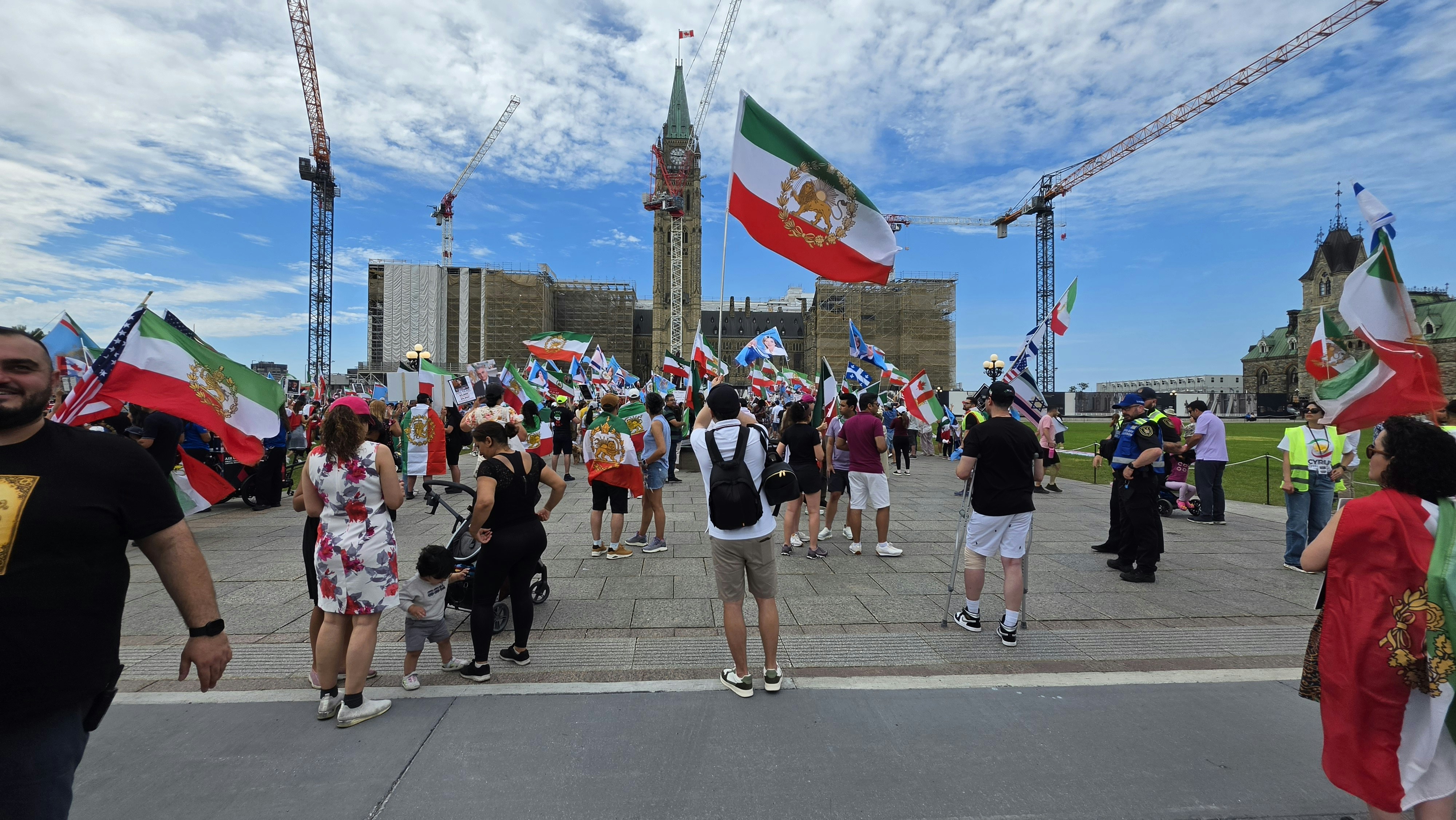 Flags and Crowds at a Civic Plaza under a Blue Sky