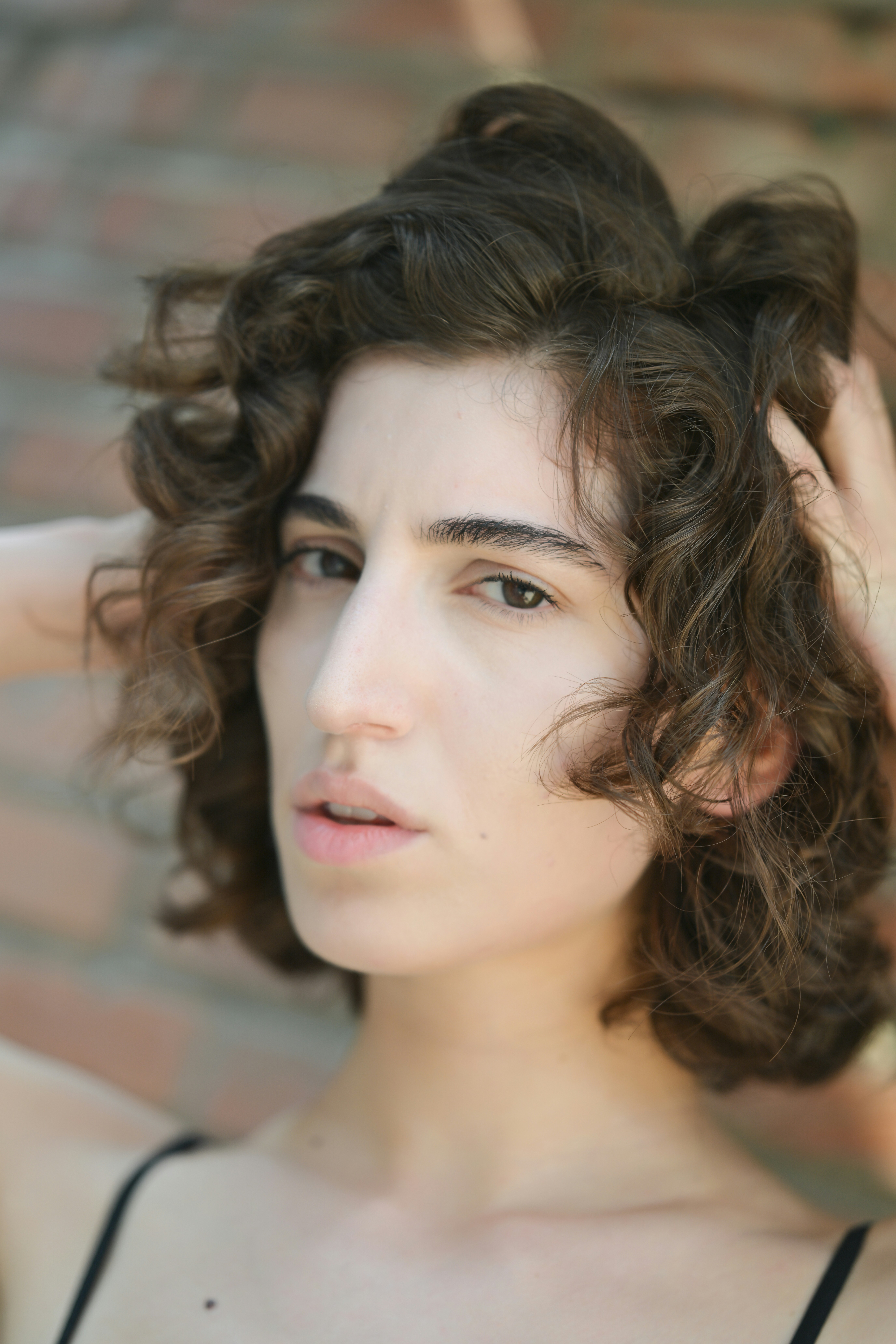 Soft Focus Portrait of a curly-haired Subject in Natural Light