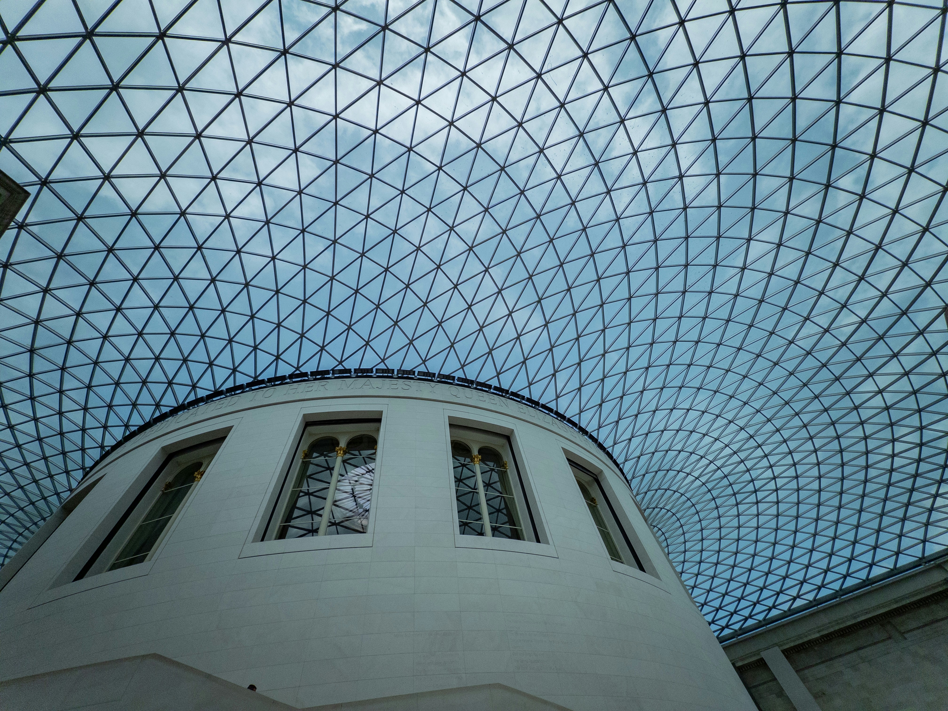 Geometric Dome Overlook: Curved Facade Beneath a Diamond Glass Ceiling