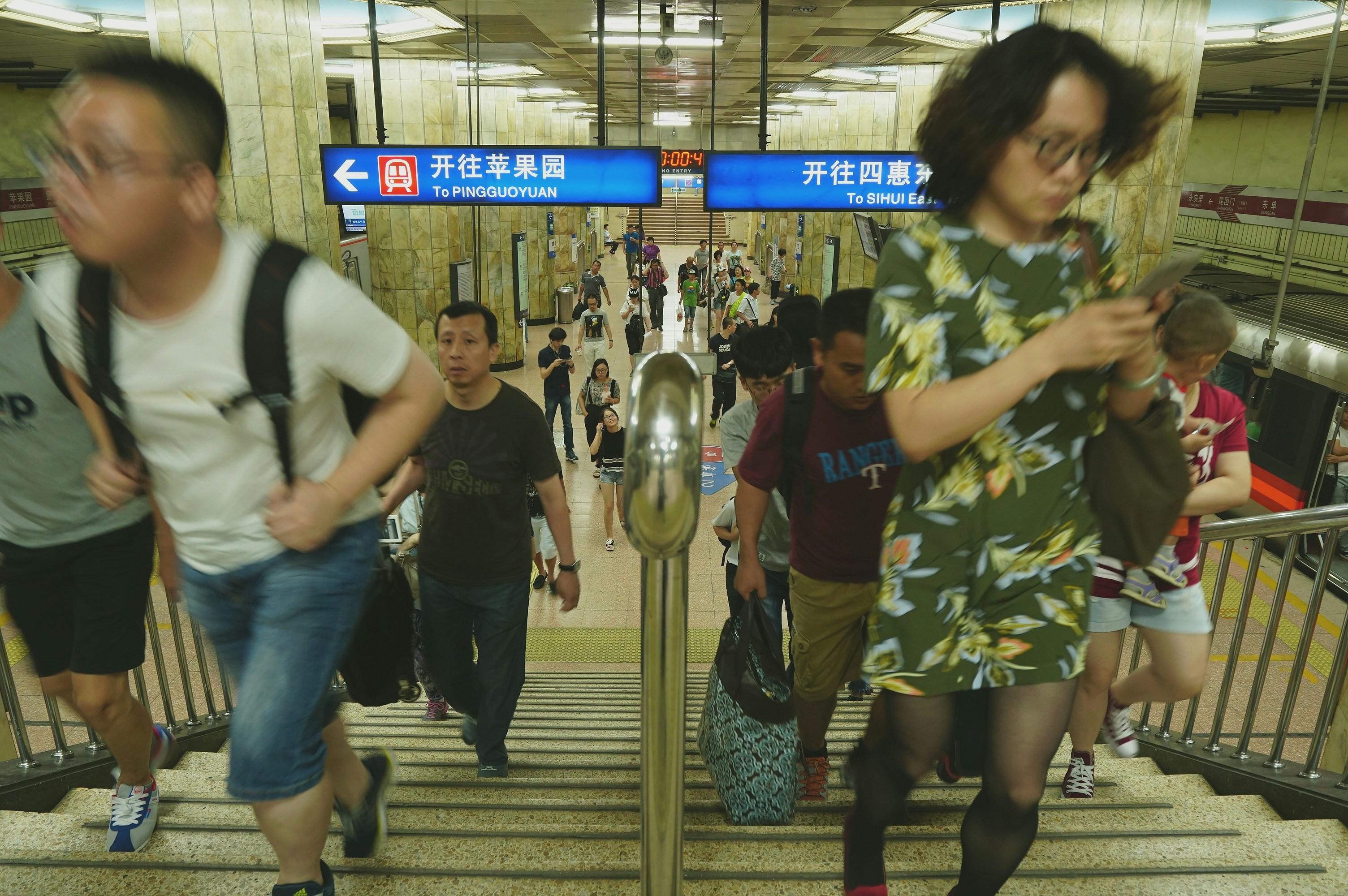 Rush Hour Ascent: People Surge Up a Subway Staircase