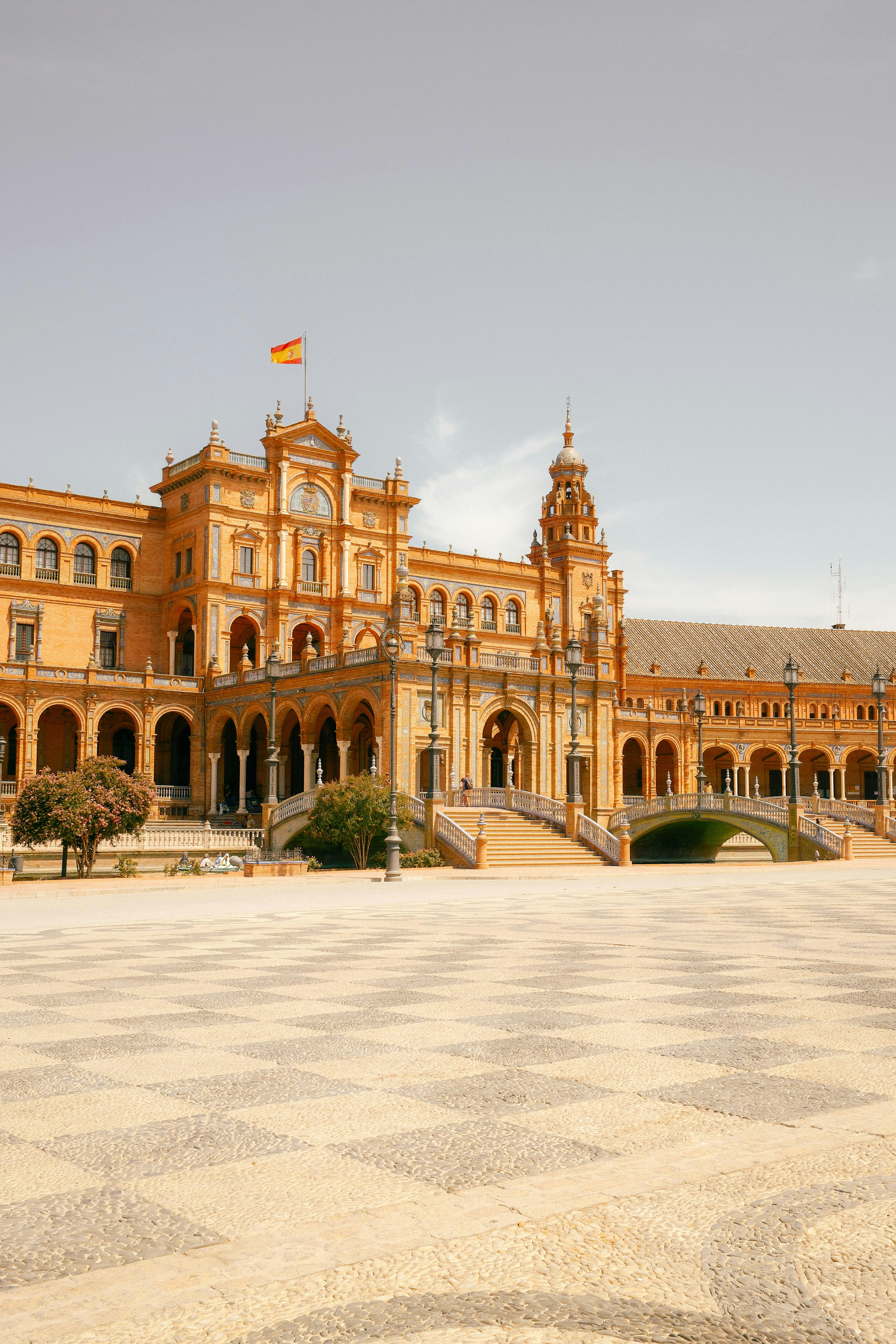 Sunlit Granada: The Plaza’s Golden Facade and Arcaded Promenade
