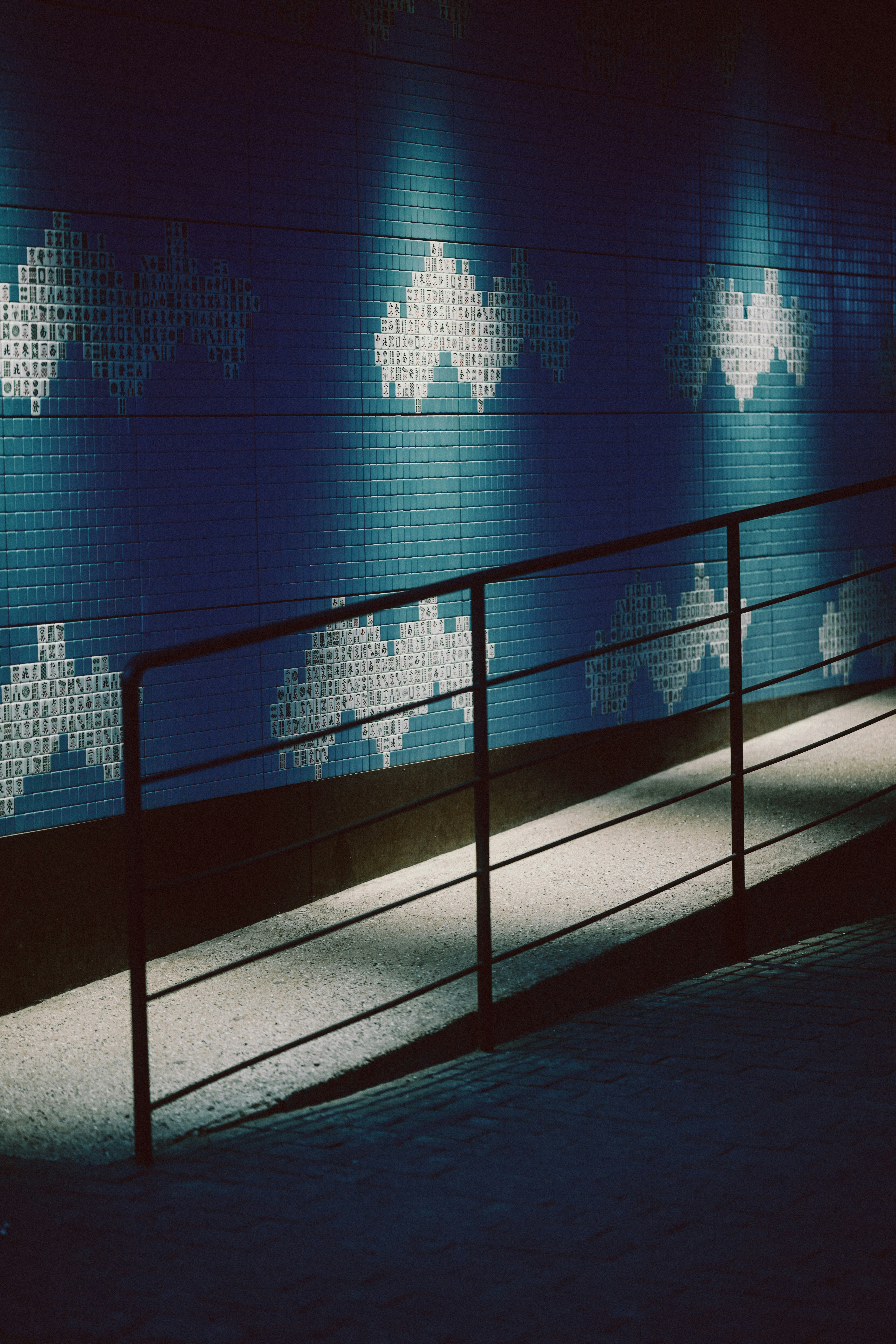 Neon Mosaic Steps: Blue Tiles and Silent Railing