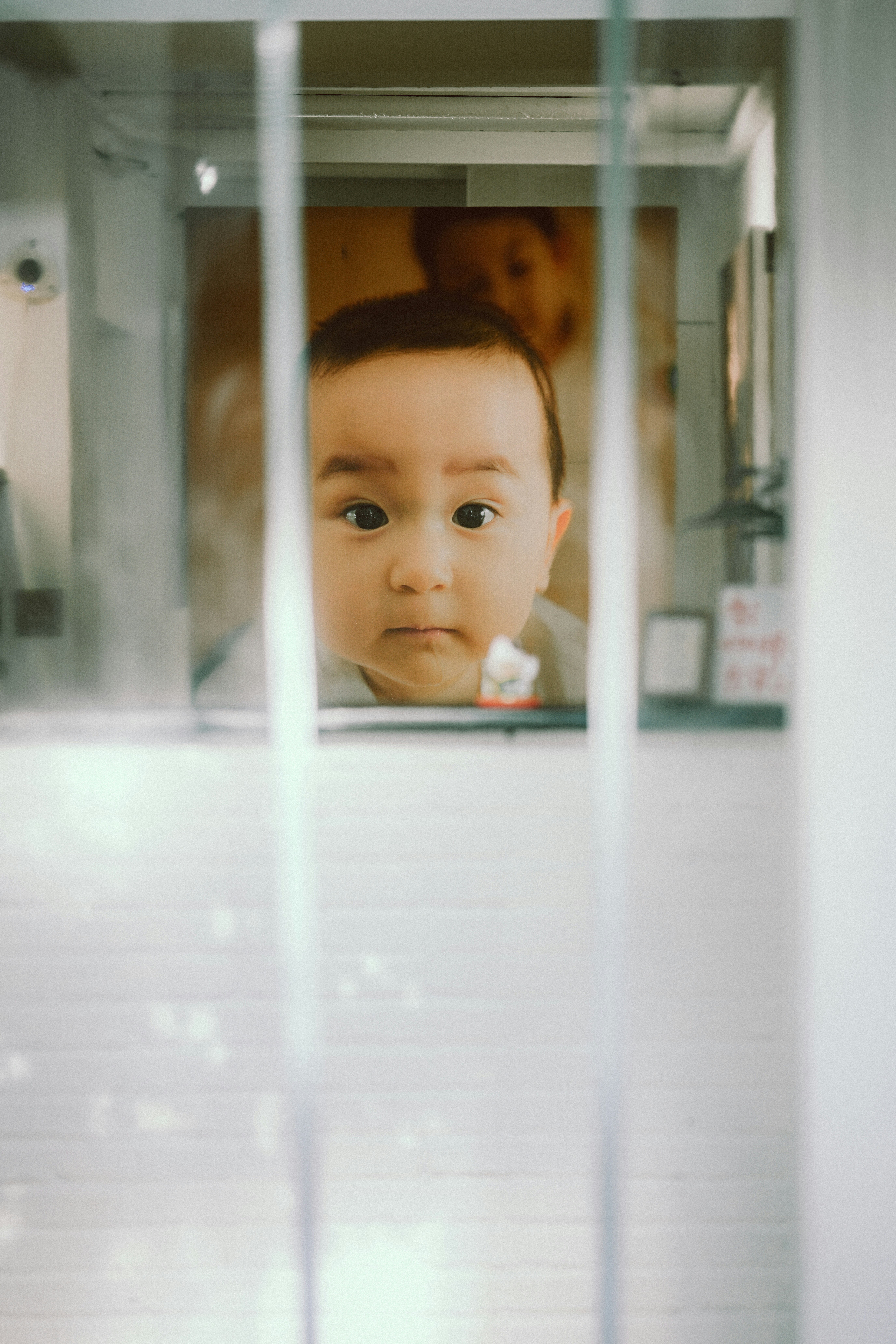 Centered Wonder: A Baby Peering Through a Windowed Frame