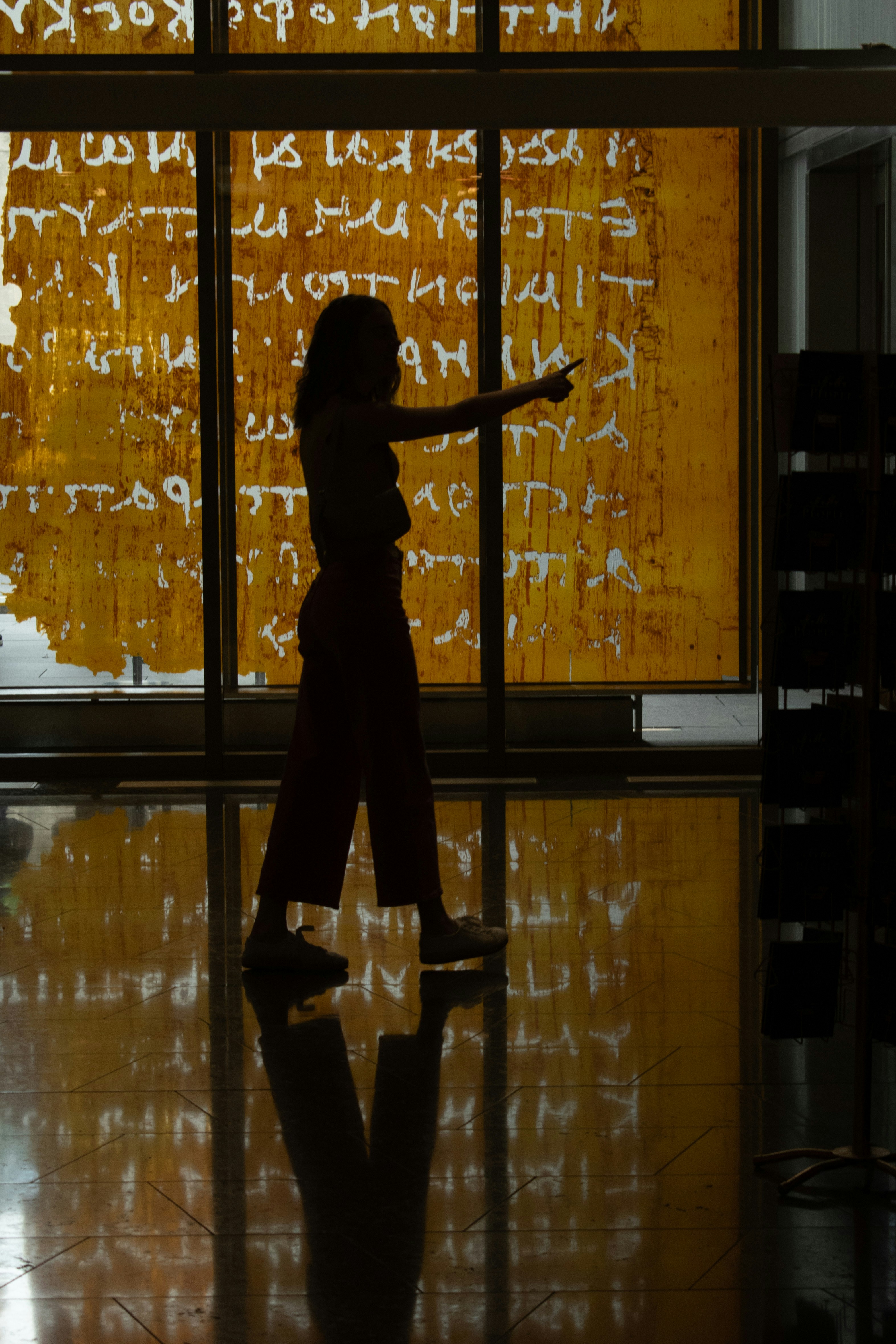 Silhouette in Motion: A Figure Reaches Toward a Glowing Window
