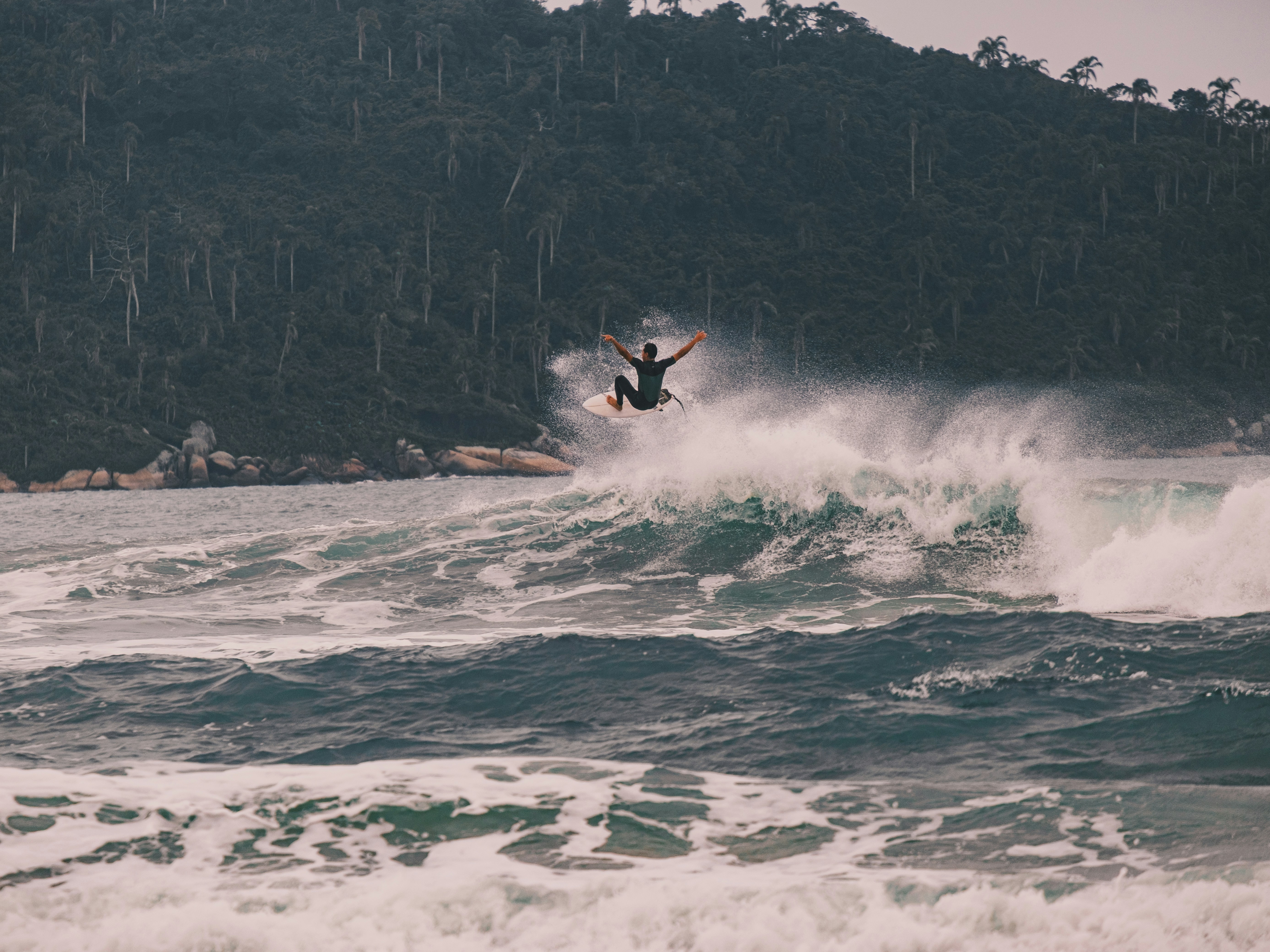 Leap of the Wave: Surfer Silhouette Against Cresting Break