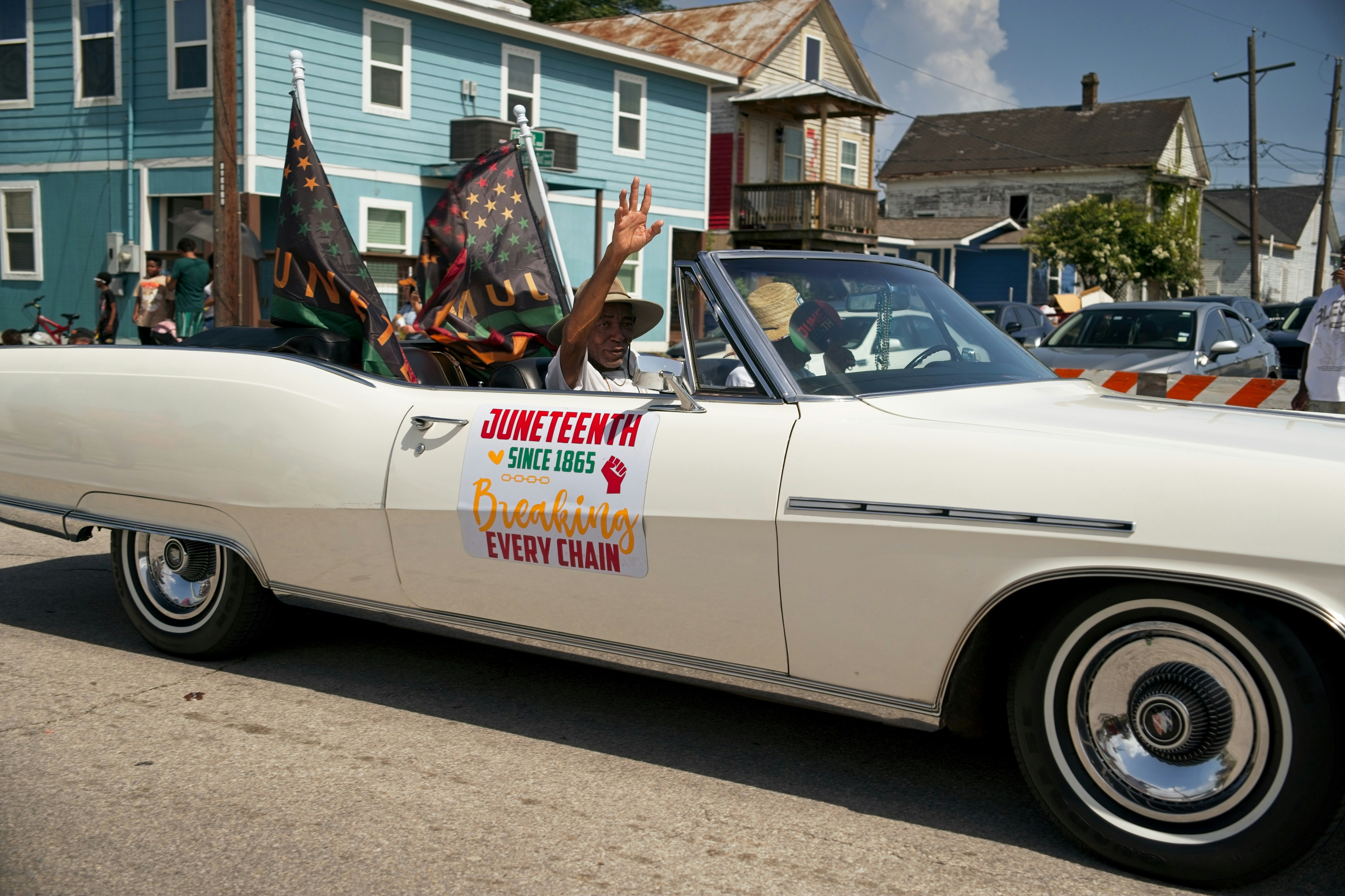 Open-Top Parade: A Classic Convertible Carries a Jubilant Group