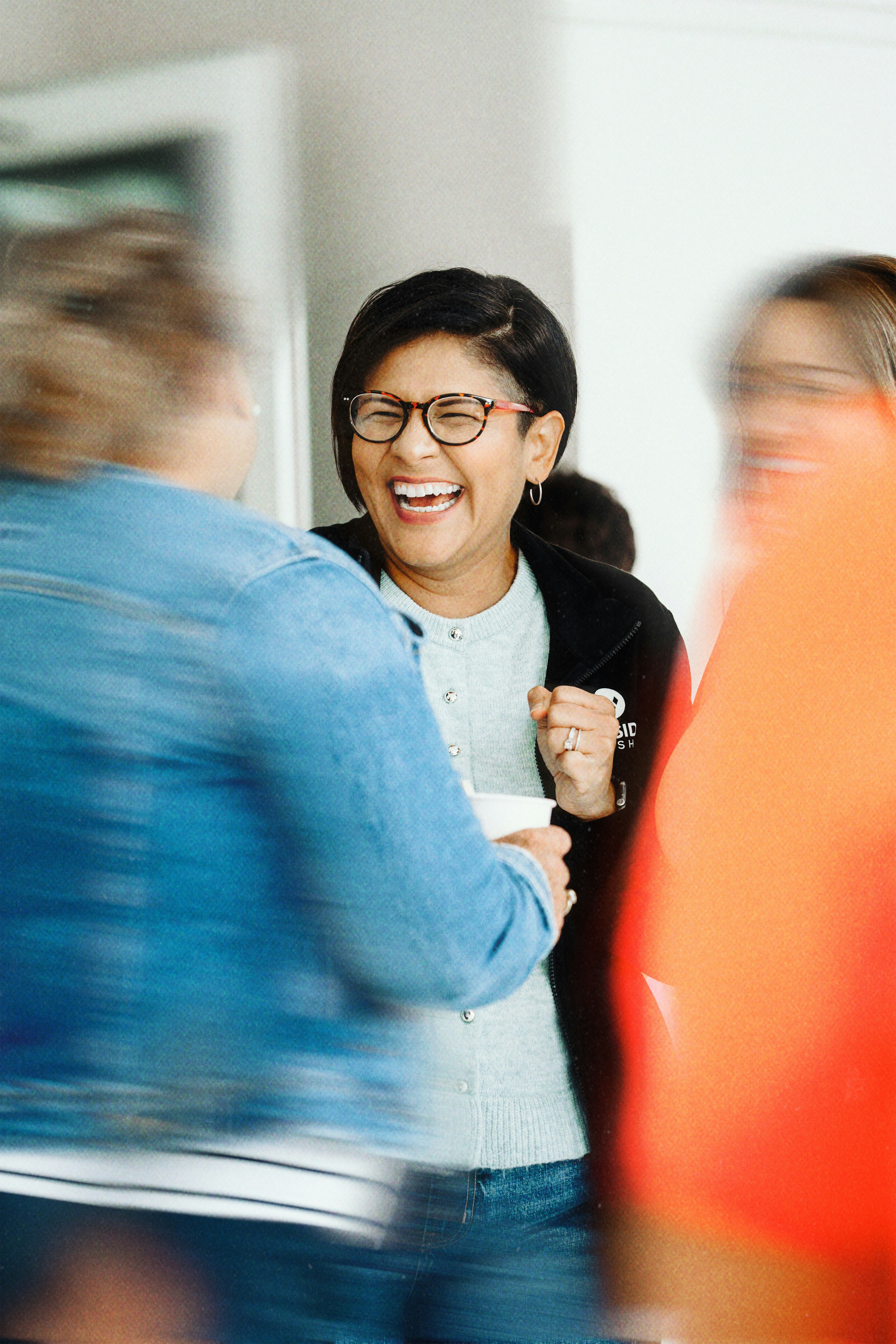 Joyful Interaction: A Laughing Moment in a Social Gathering