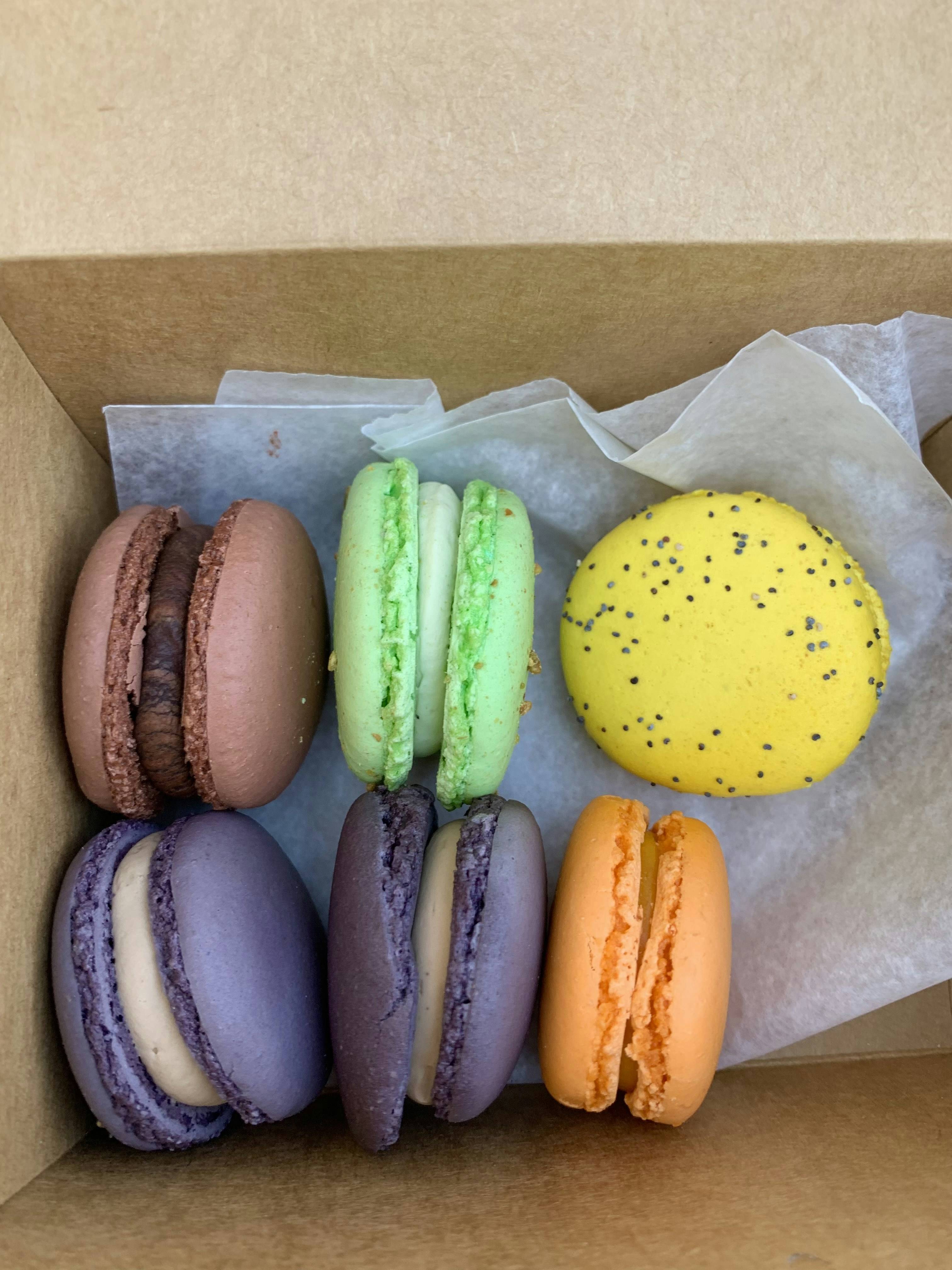 Assorted Chocolate, Pistachio, and Citrus Macarons in a Cardboard Box