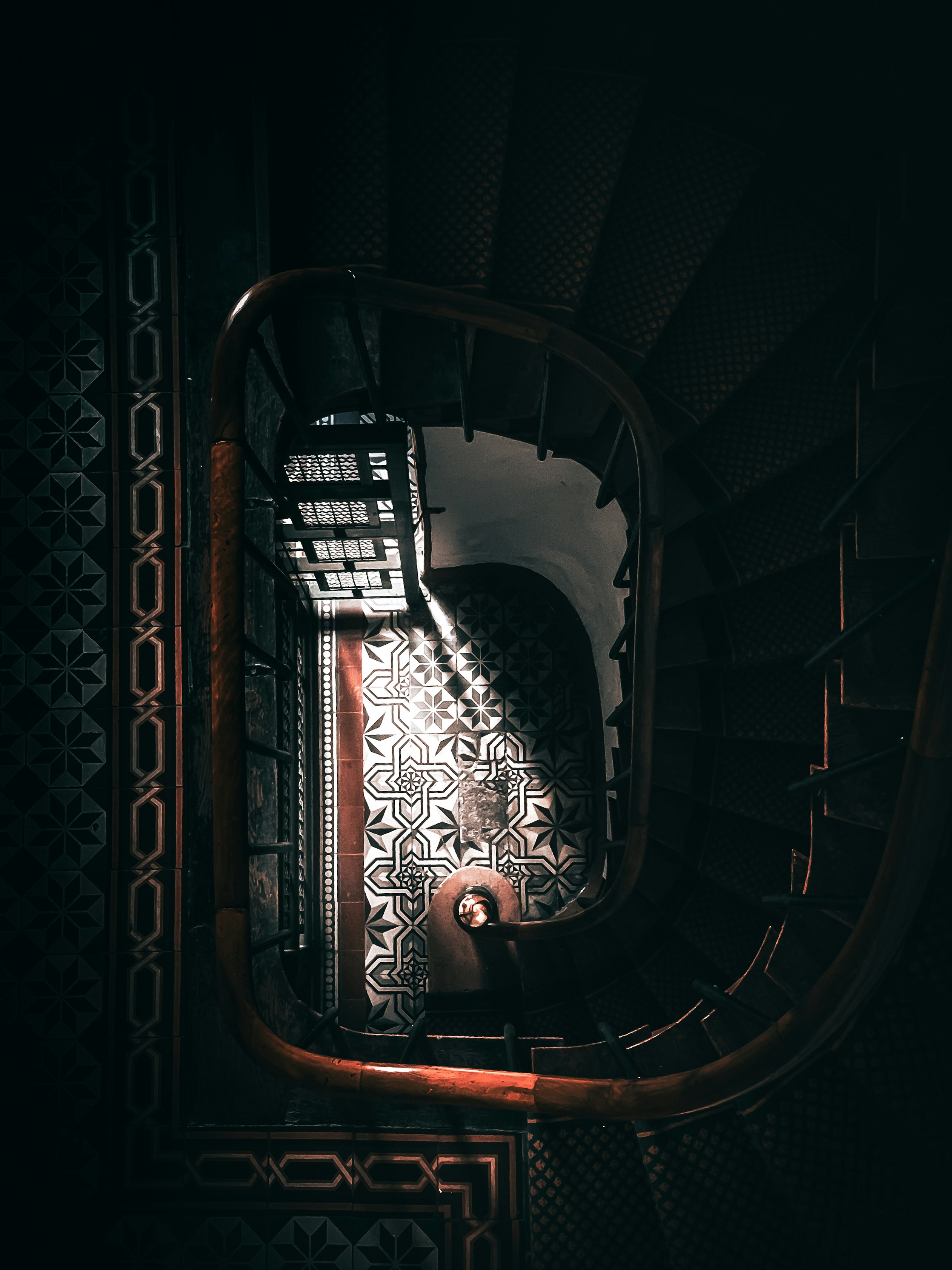 Spiral Staircase Echoes: Neon Tile Light Traces Down a Winding Flight