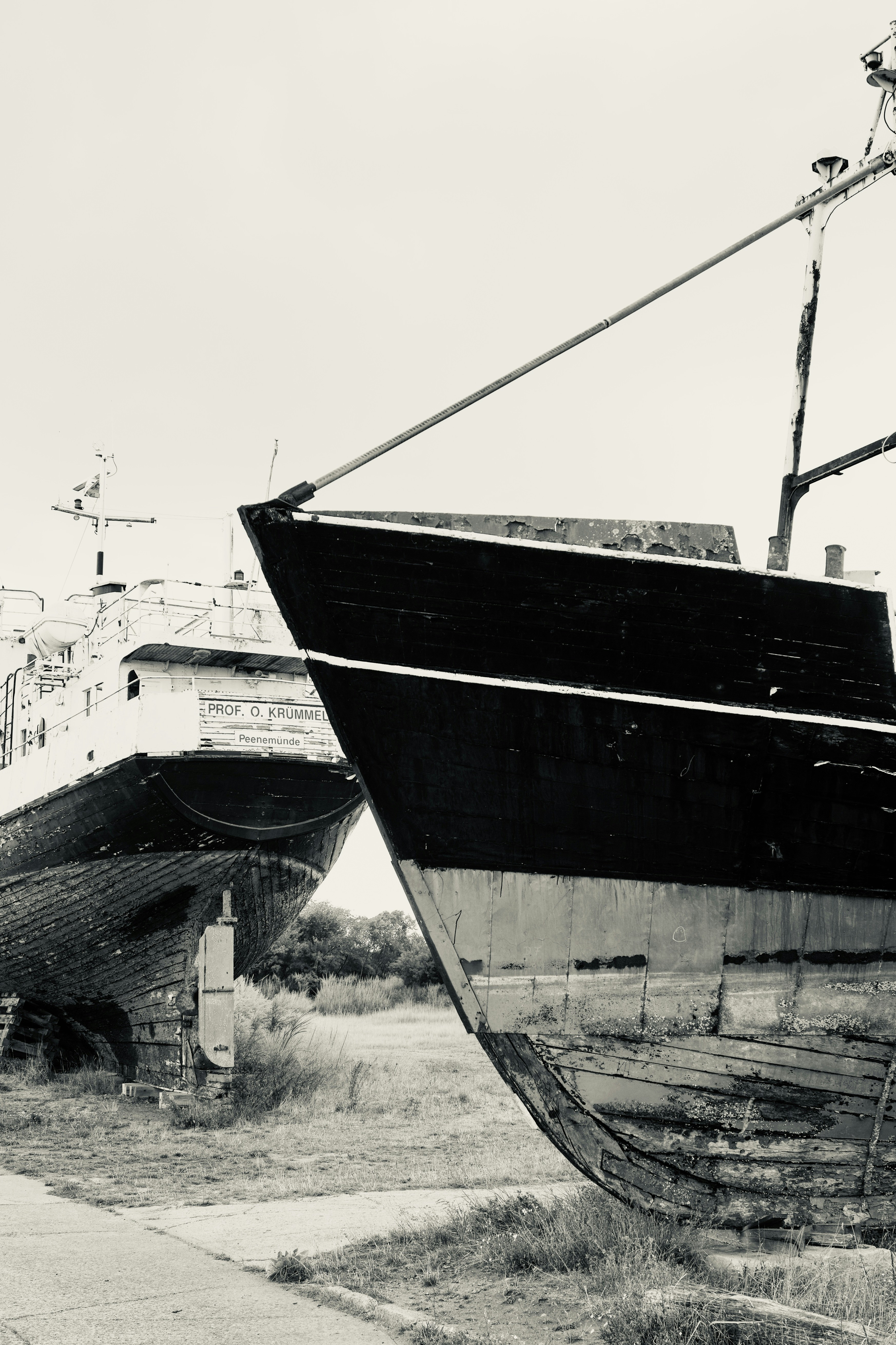 Hull Overhang: a Pair of Abandoned Vessels Resting in Quiet Shoreline Light
