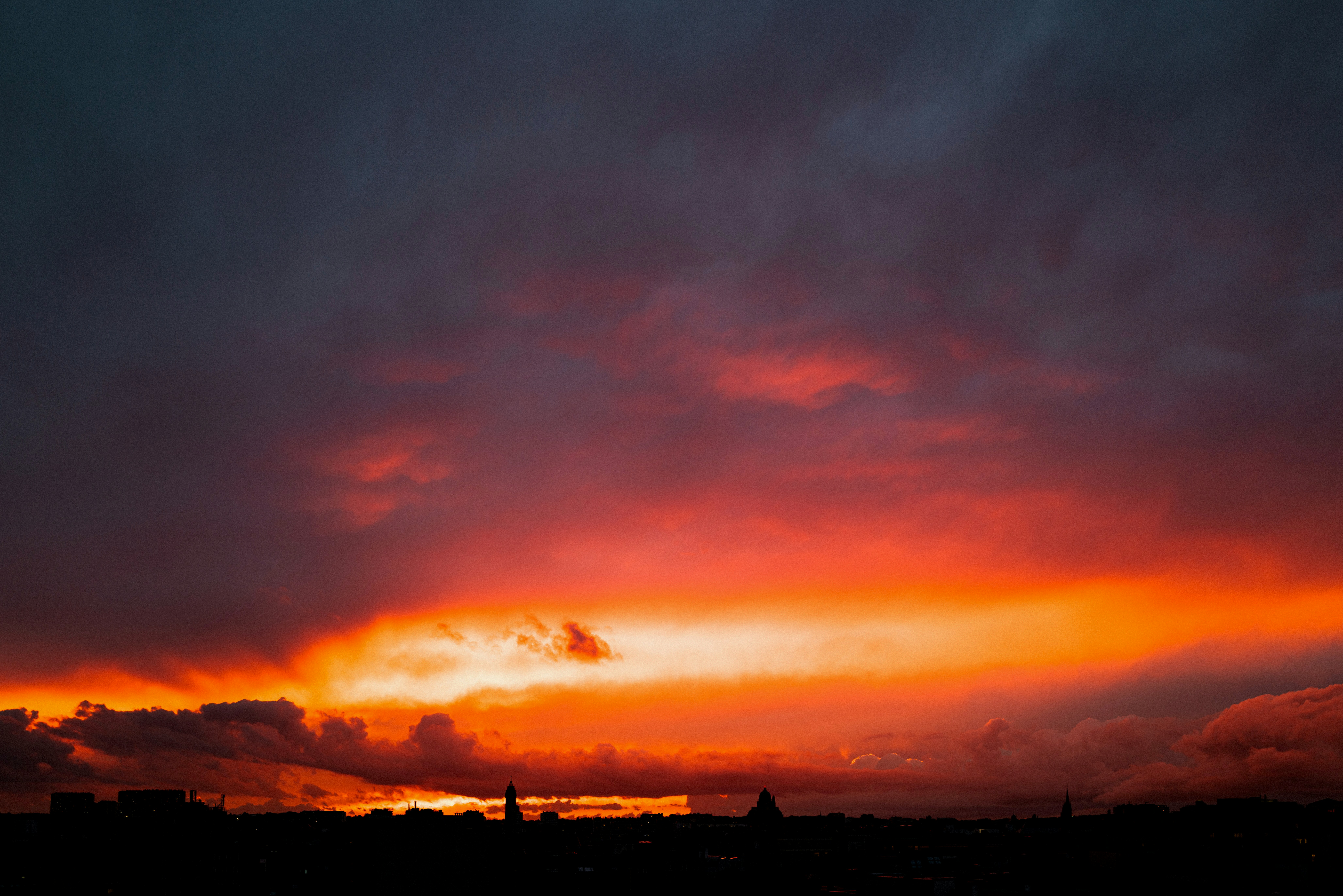 Dawn's Narrow Band: Fire in the Horizon Over a Quiet City