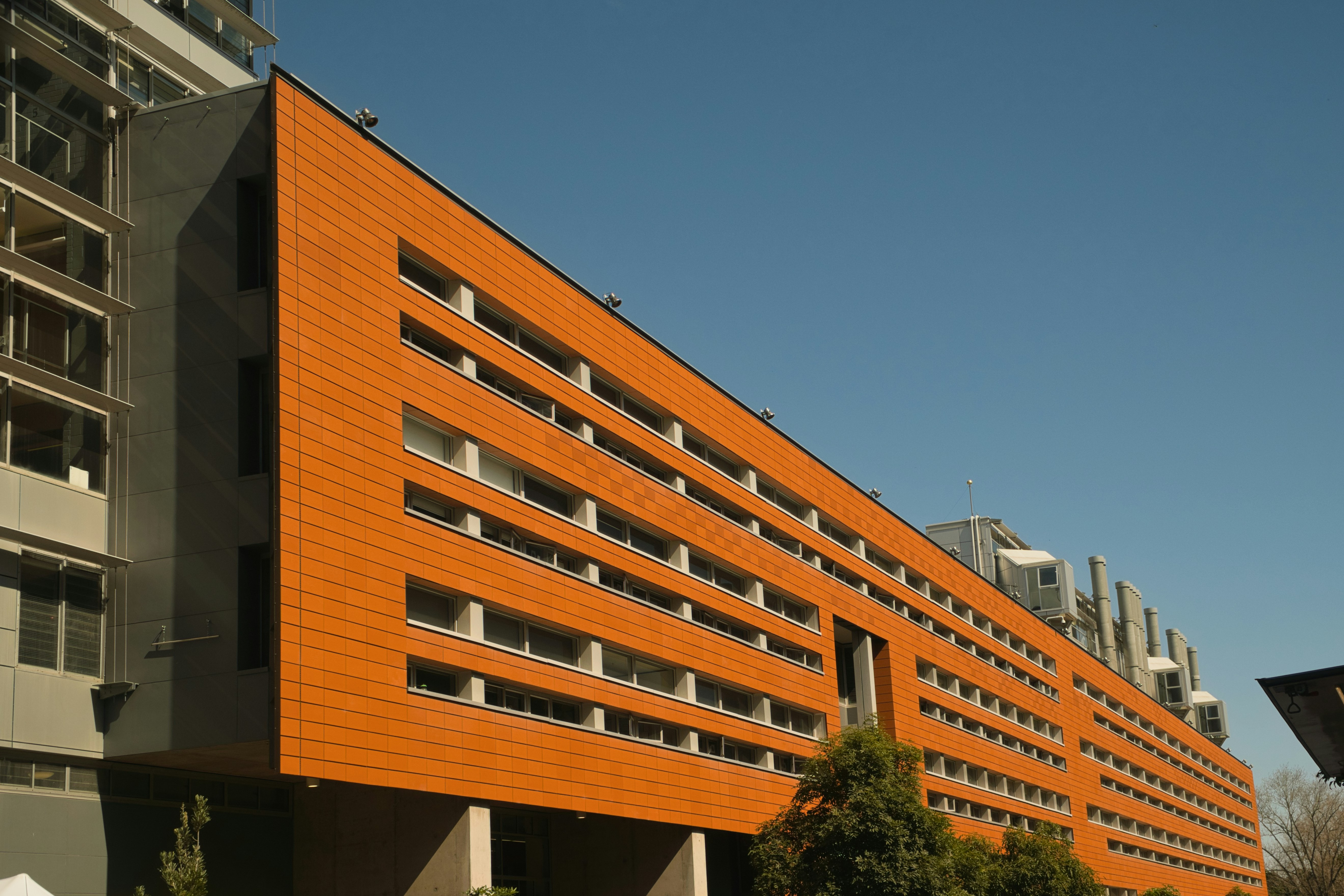 Orange Facade, Parallel Lines: A Modern Building's Long Shadow