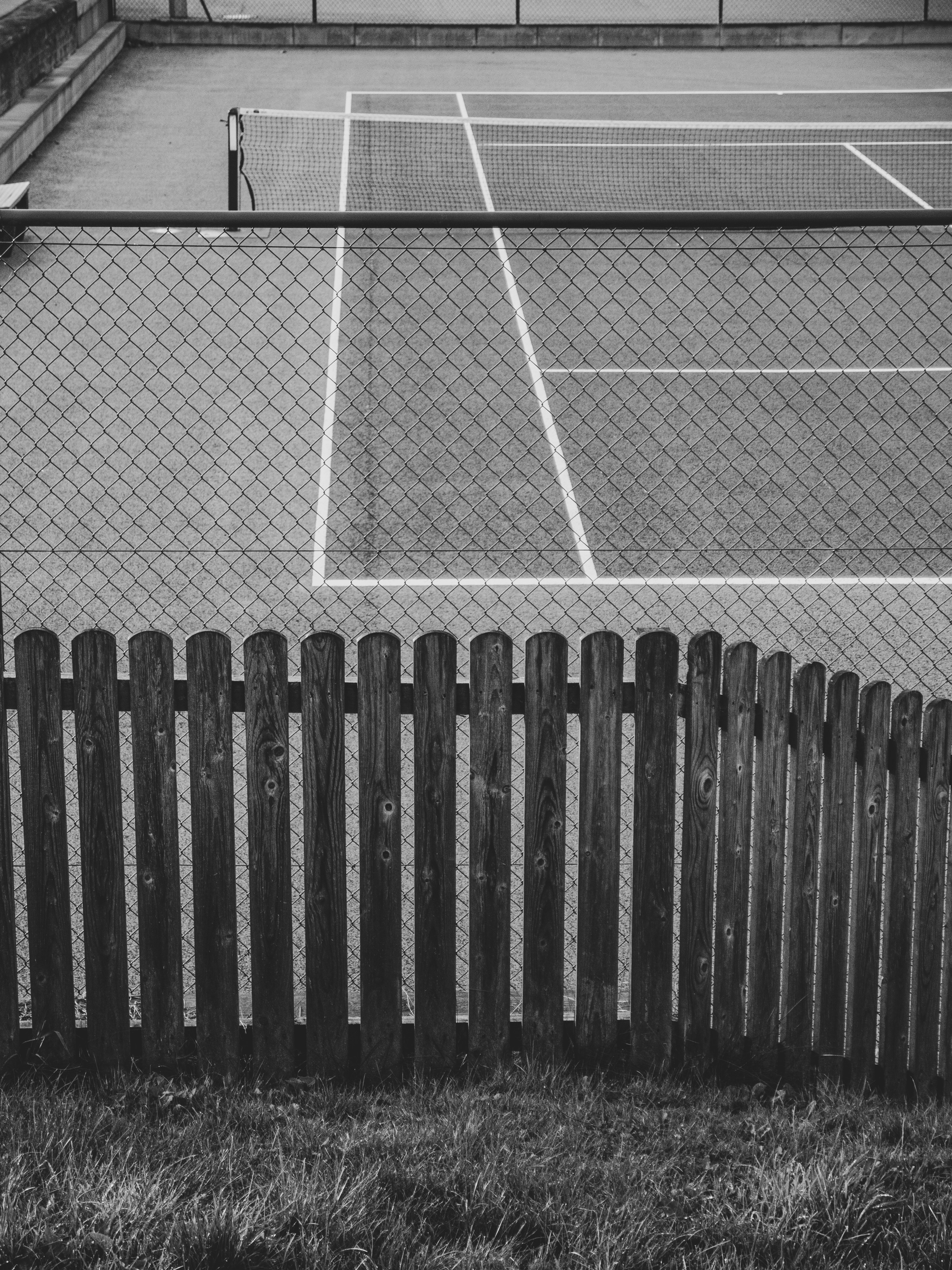 Fence Line at the Tennis Court: A Quiet Grayscale Boundary