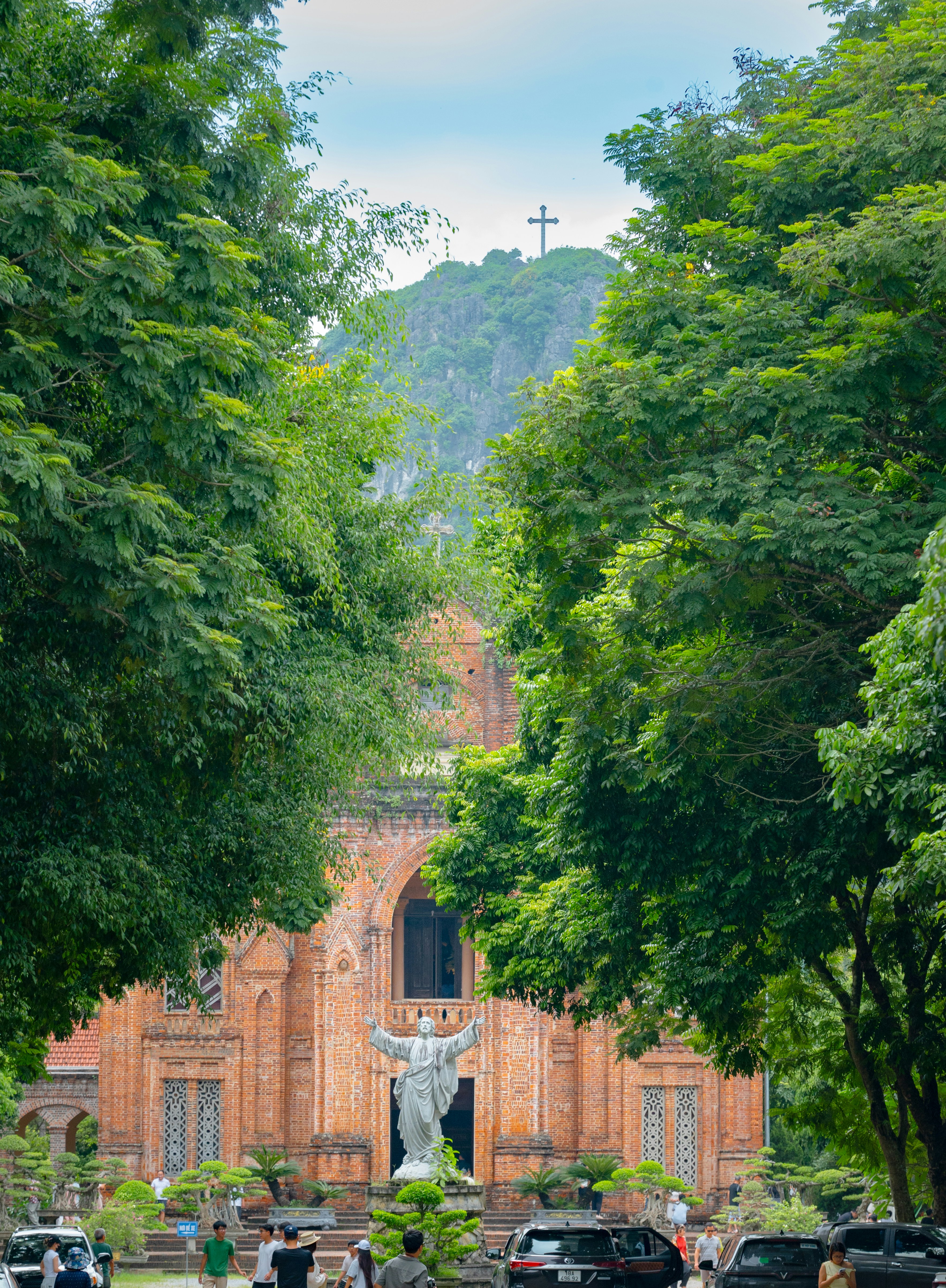 Cruciform Bell Tower Framed by Green Cathedrals