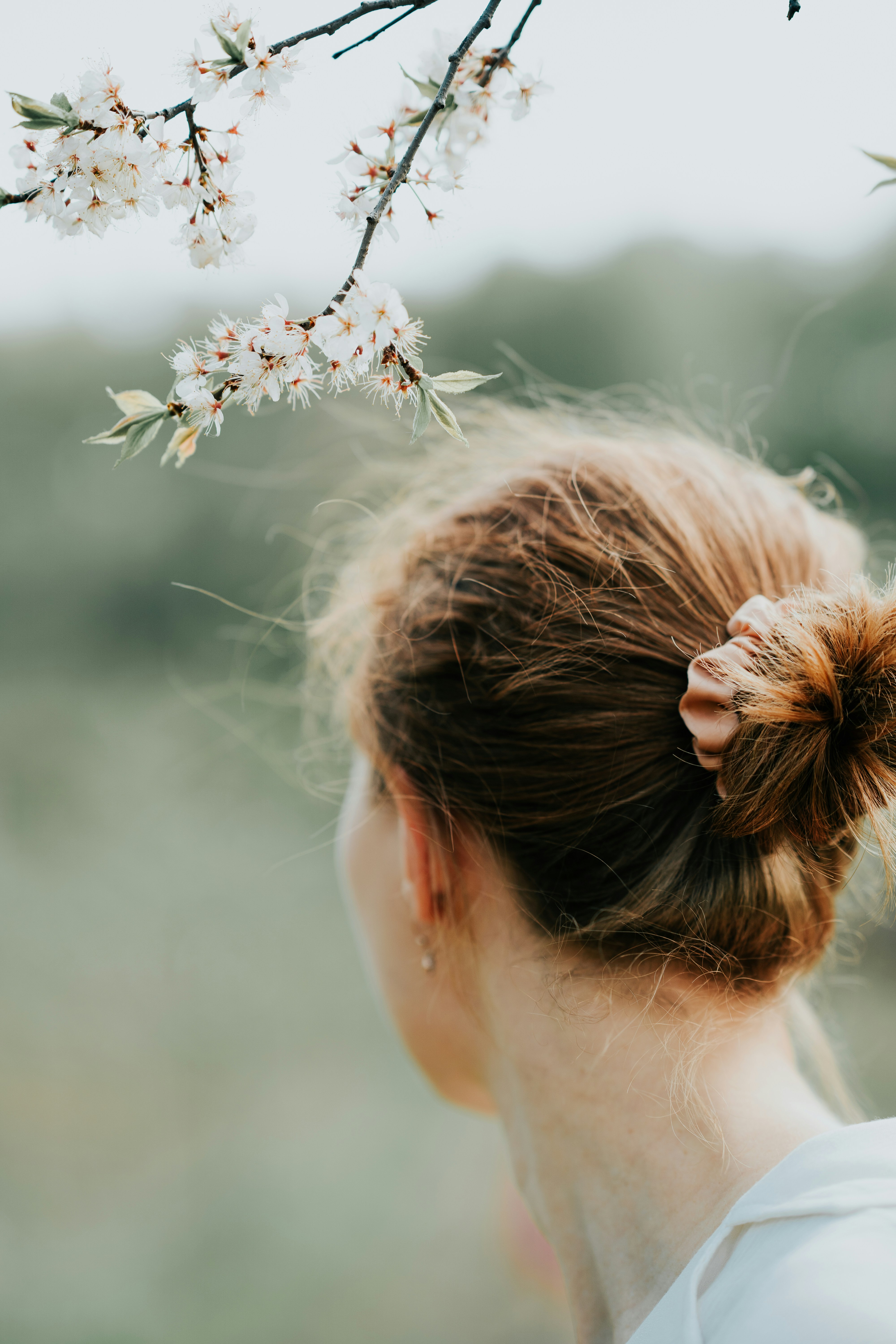 Soft Focus in Bloom: Portrait Under Cherry Branches