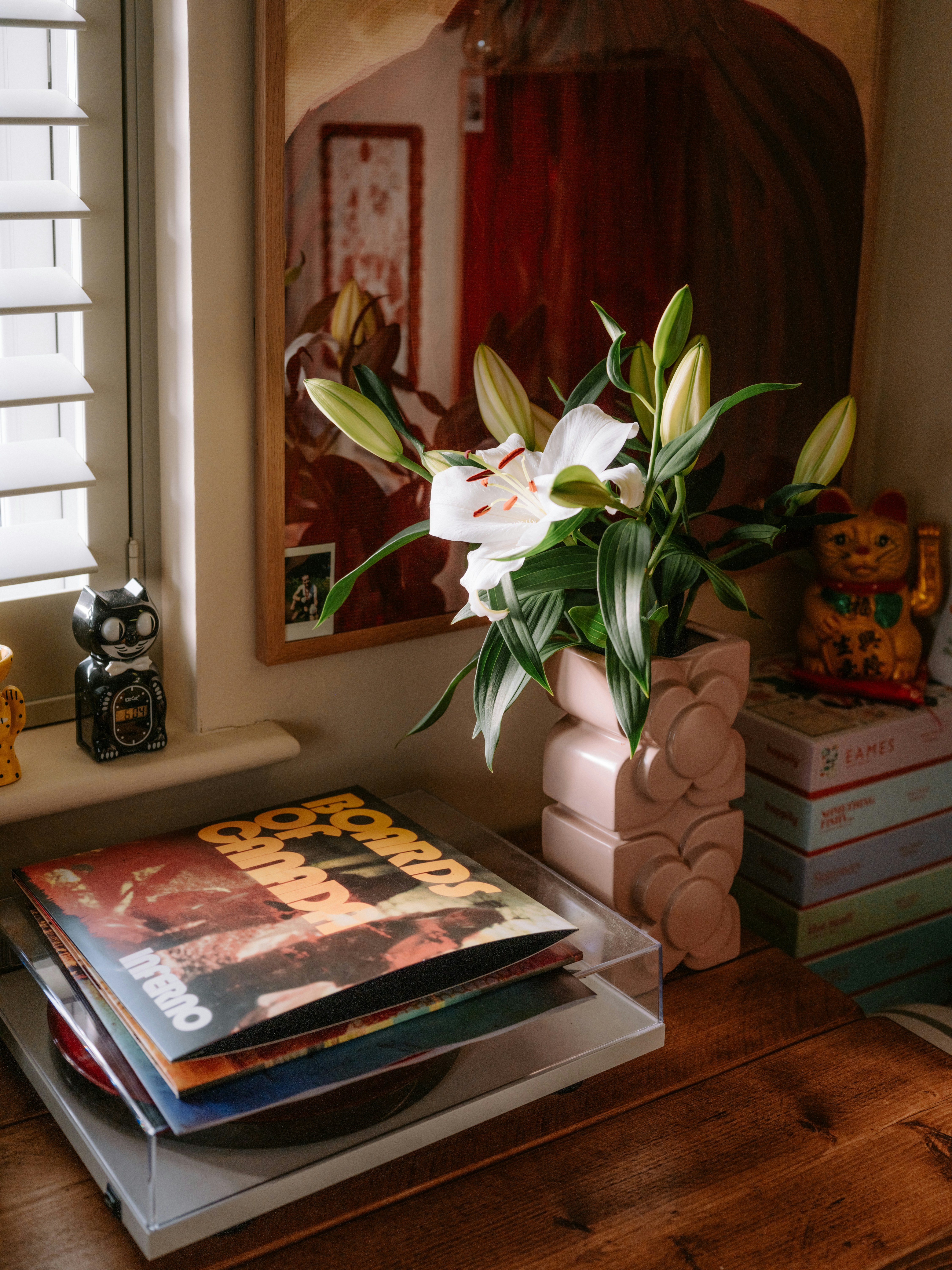 White Lily Arrangement on a Wooden Desk with Vintage Treasures