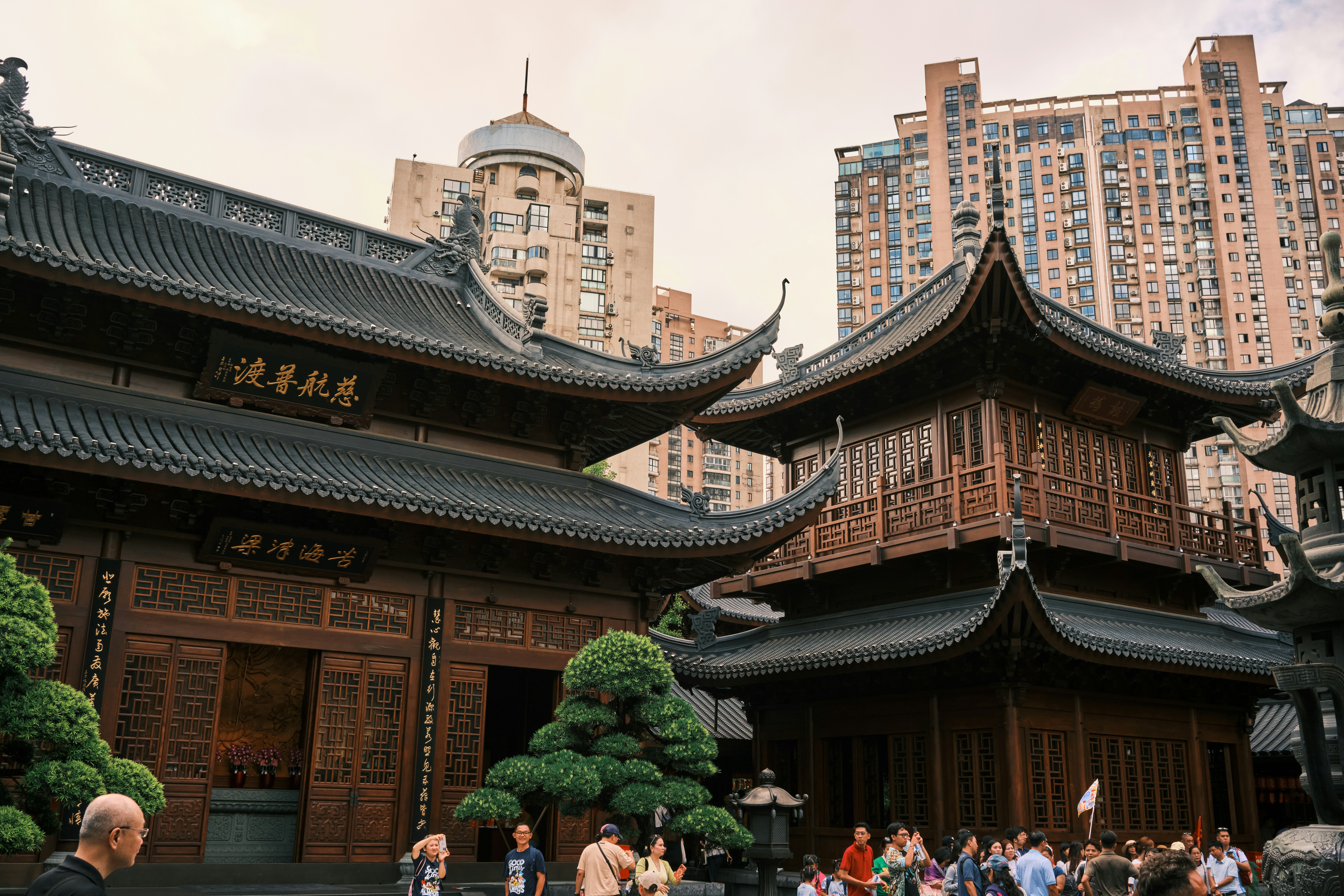 Temple Courtyard Confluence: Traditional Rooflines Meet Urban Backdrop