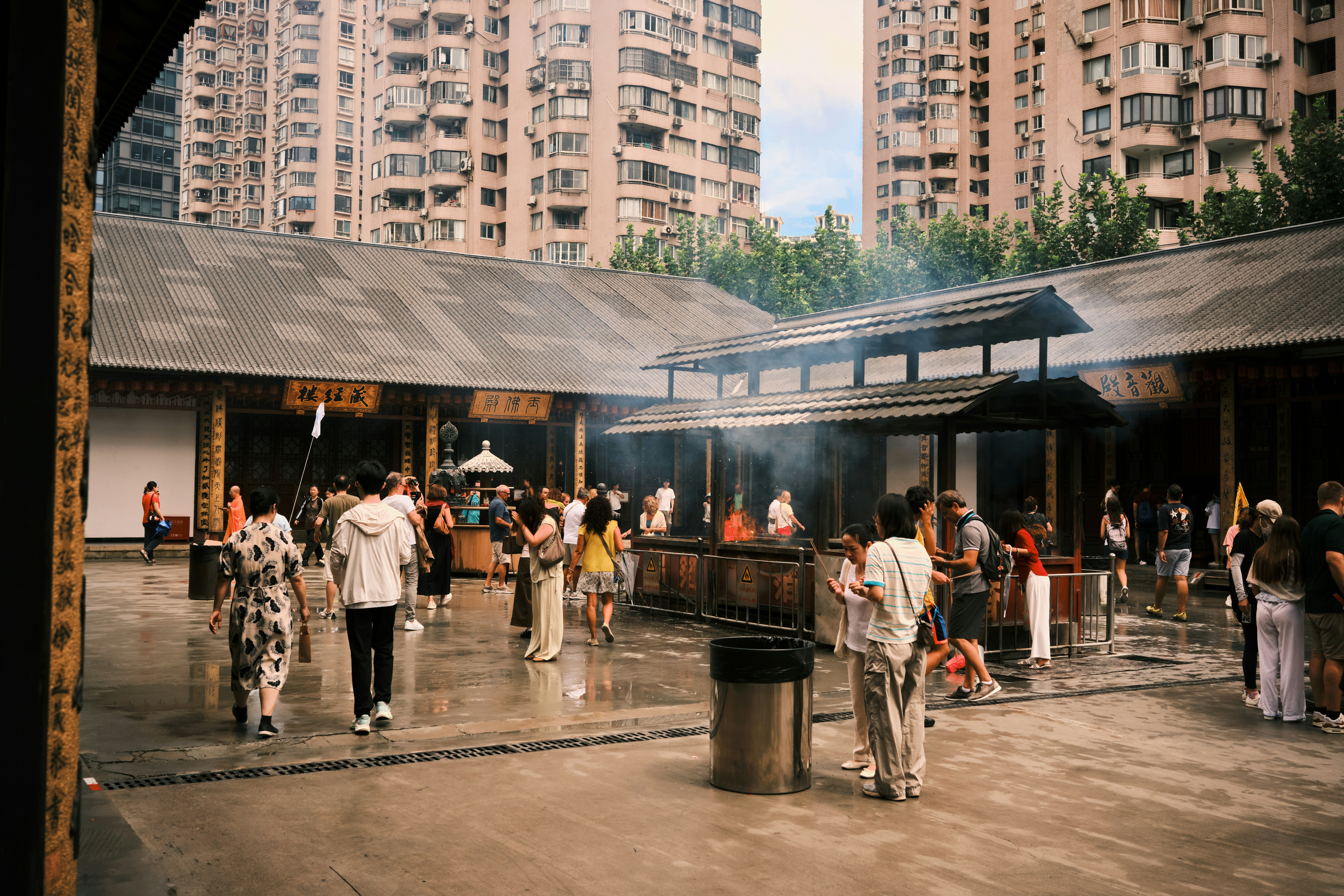 Courtyard Echoes: People Gather Under a Smoke‑Laced Roof