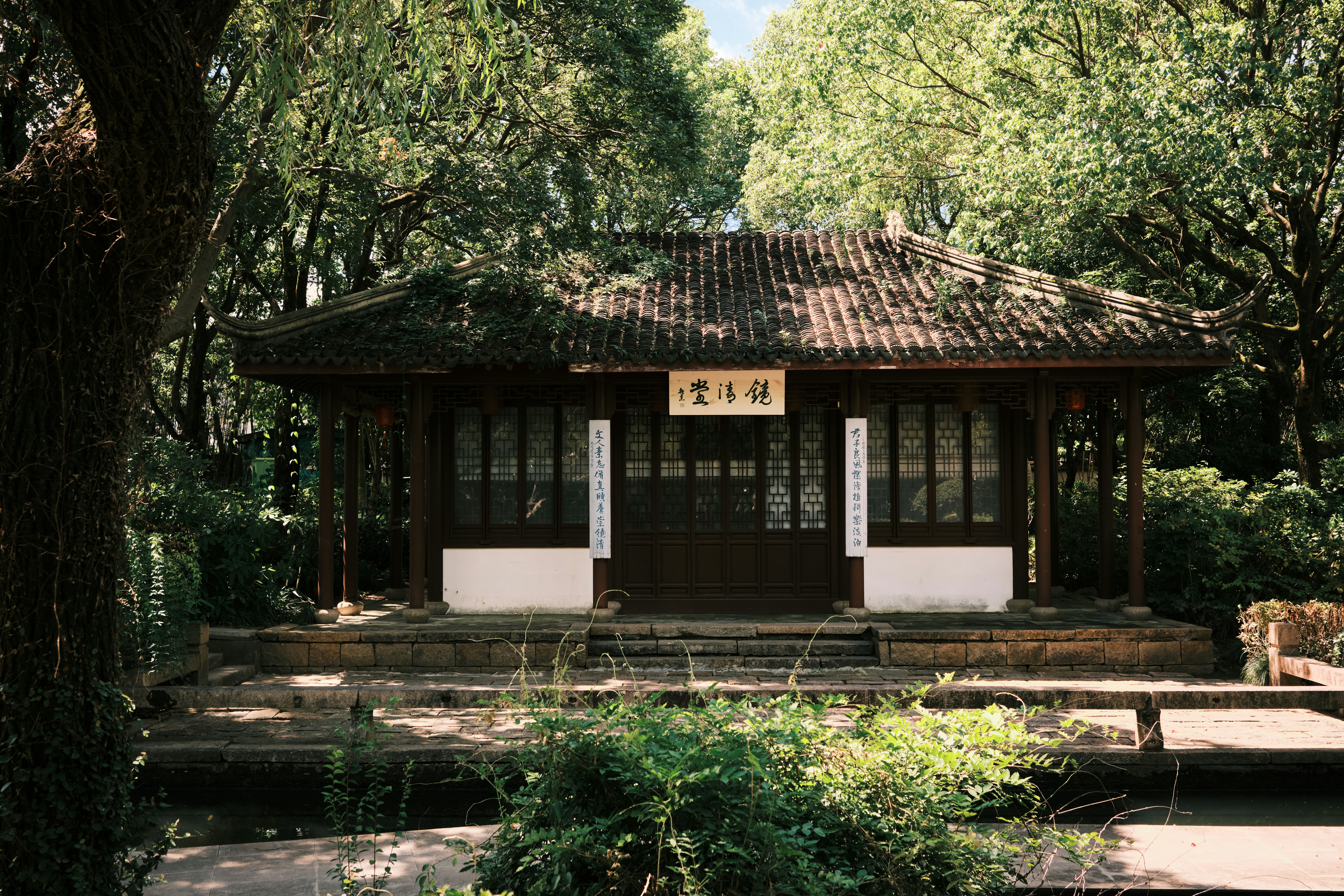 Temple Hall in Quiet Garden, Sunlit with Lush Surrounds