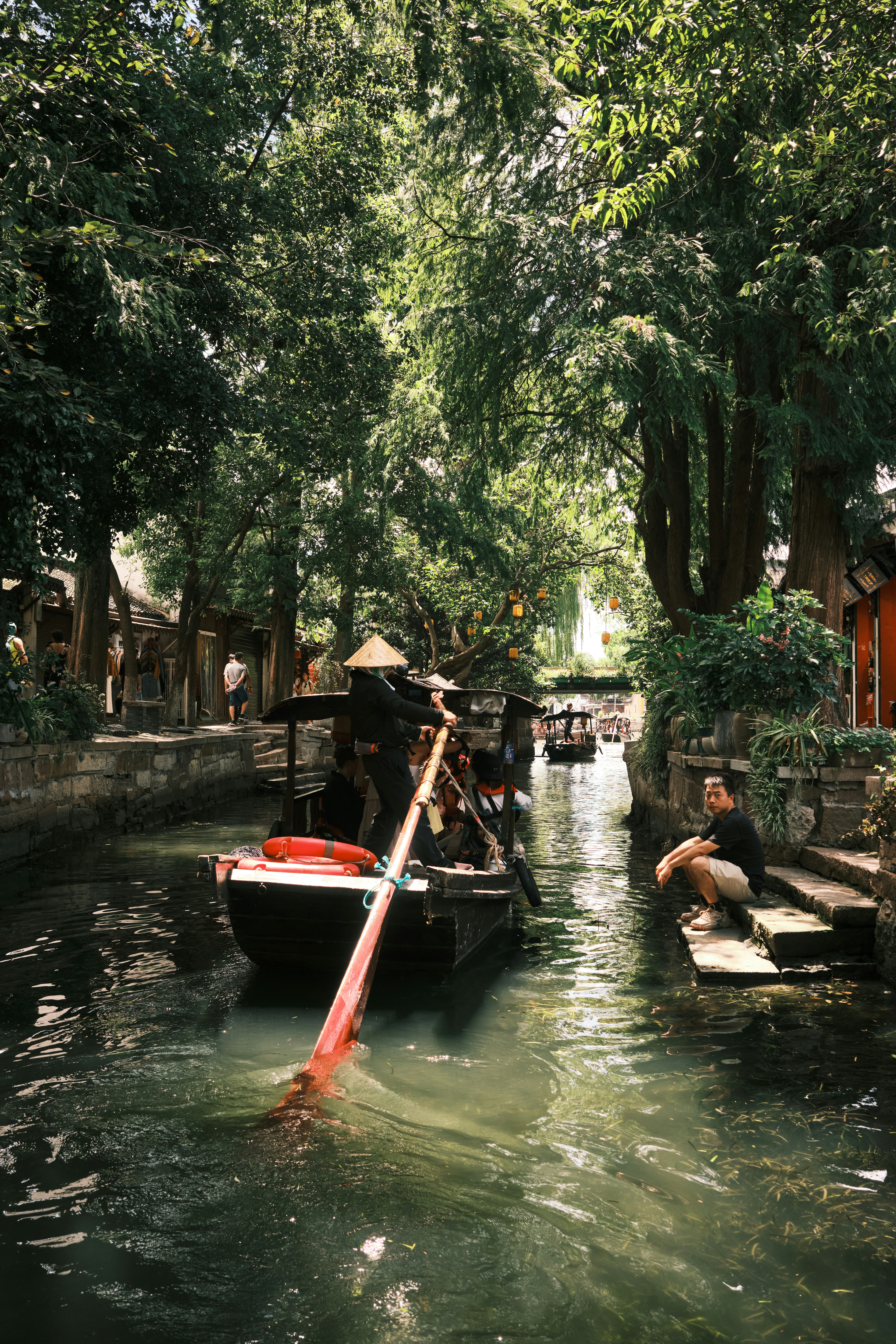 Boat on a Tranquil Canal Amid Shaded Alley of Old Town