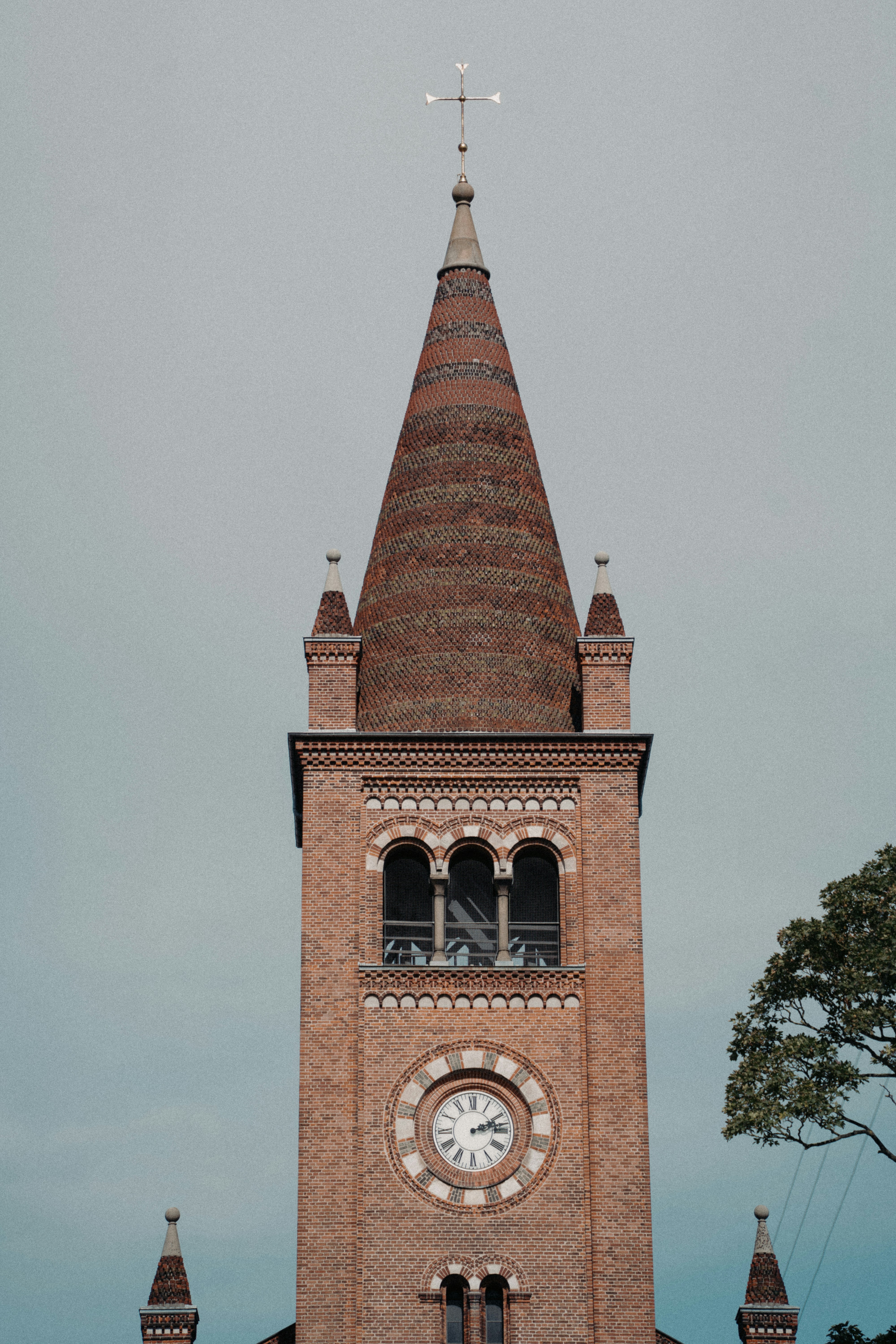 Towering Brick Clock: A Conical Spire Reaches Skyward
