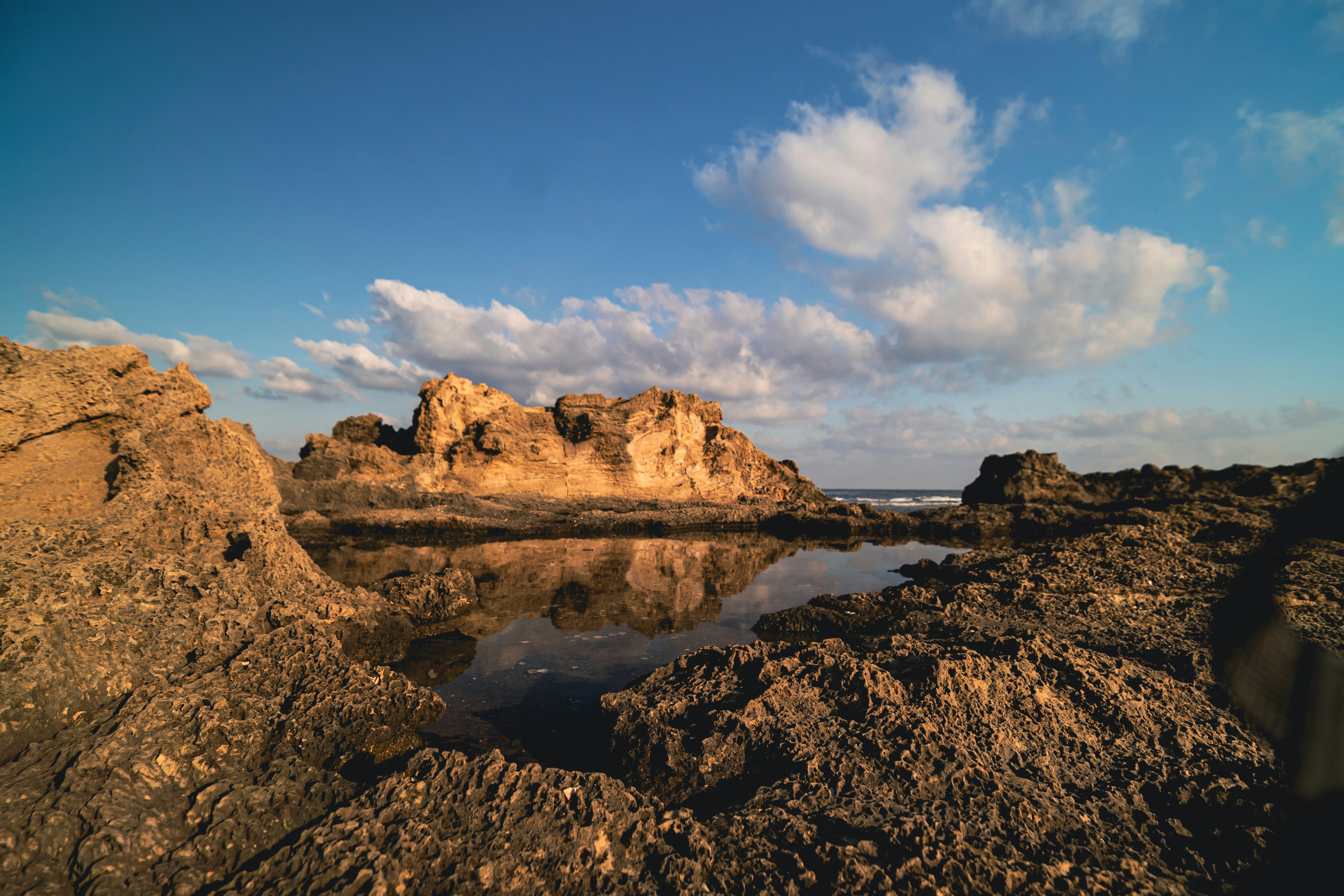 Rugged tidal flats under a vast blue sky