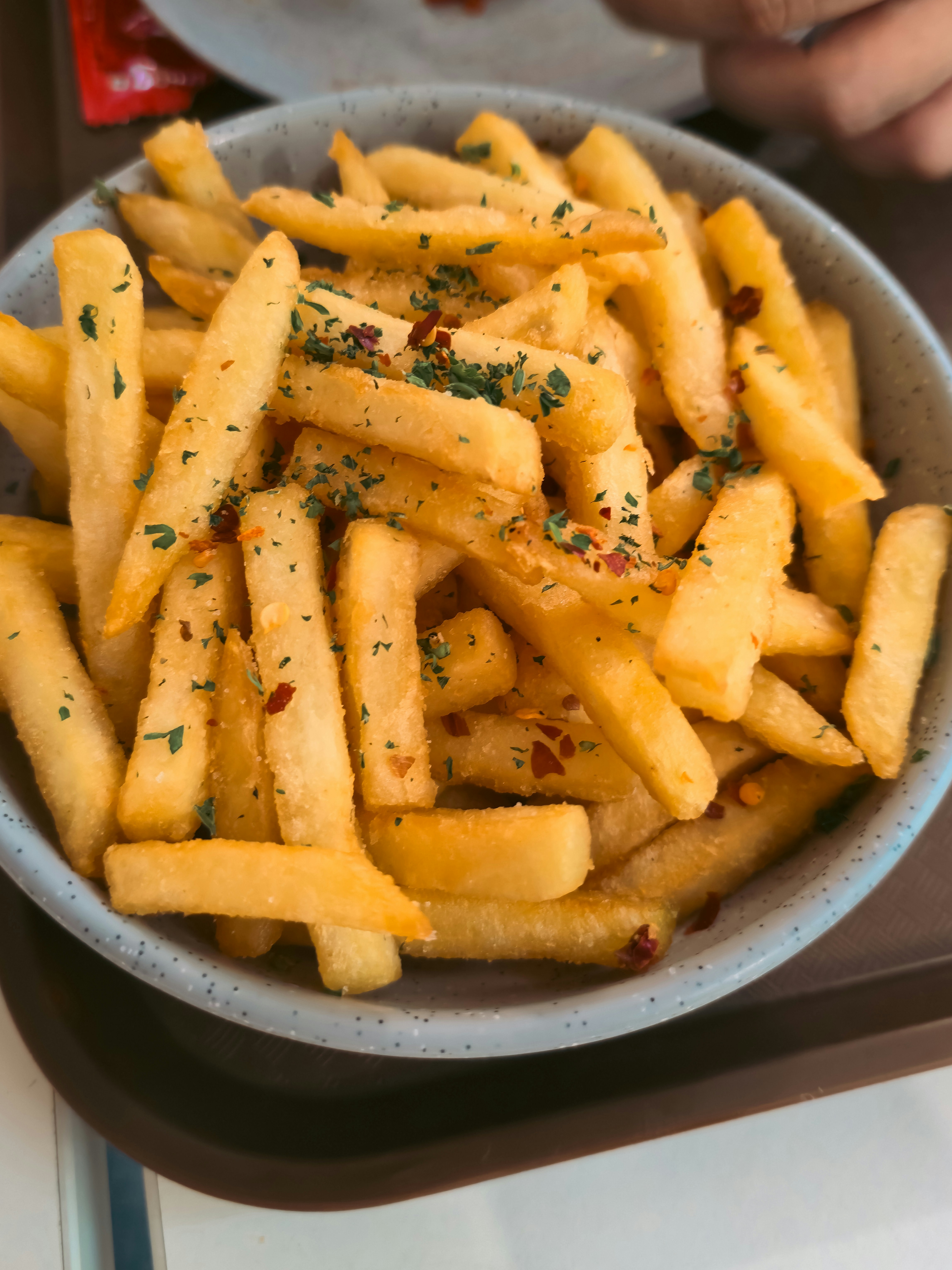 Crispy Herb-Speckled Fries in a Creamy Bowl