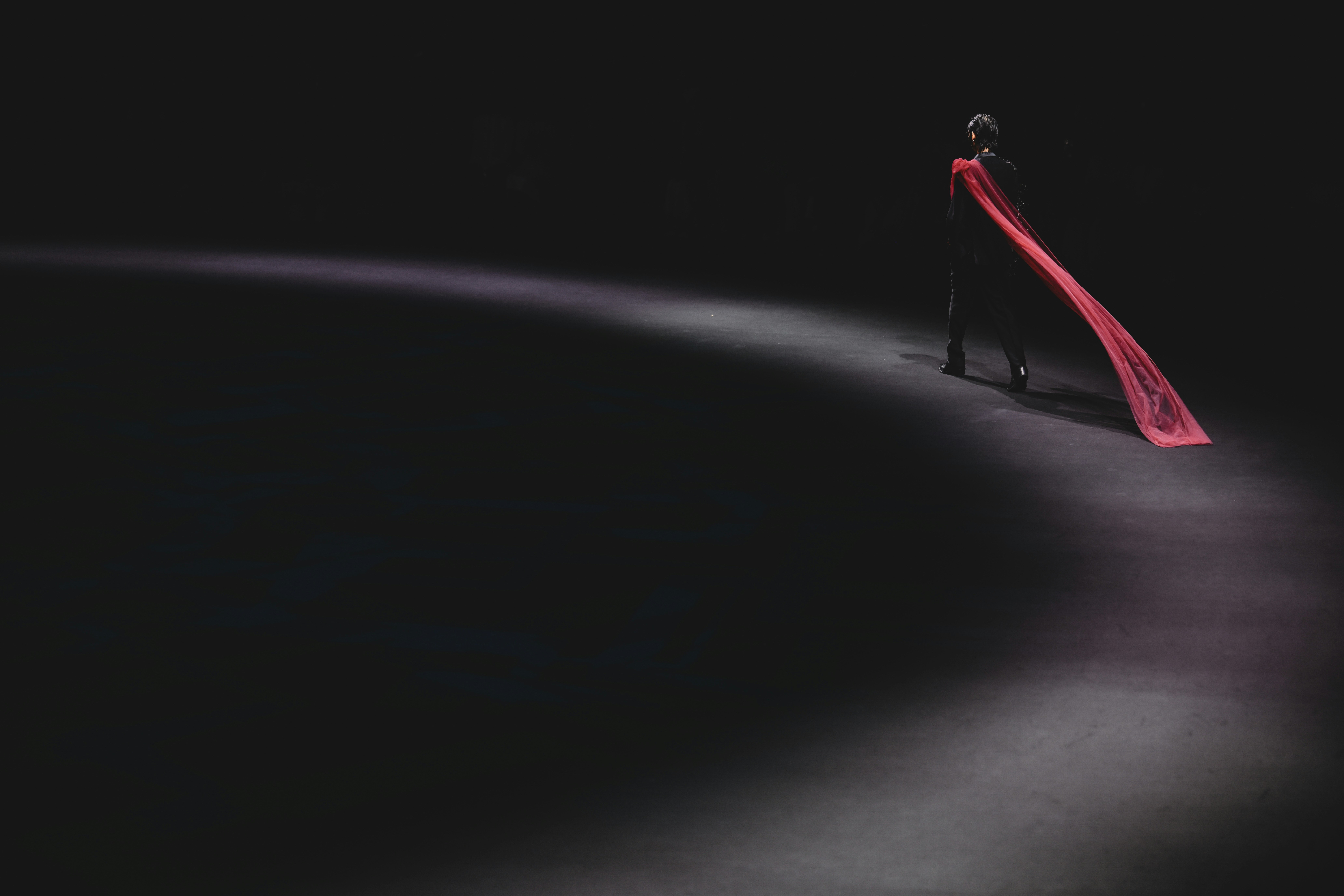 Isolated Red Silk: A Figure in a Spotlight