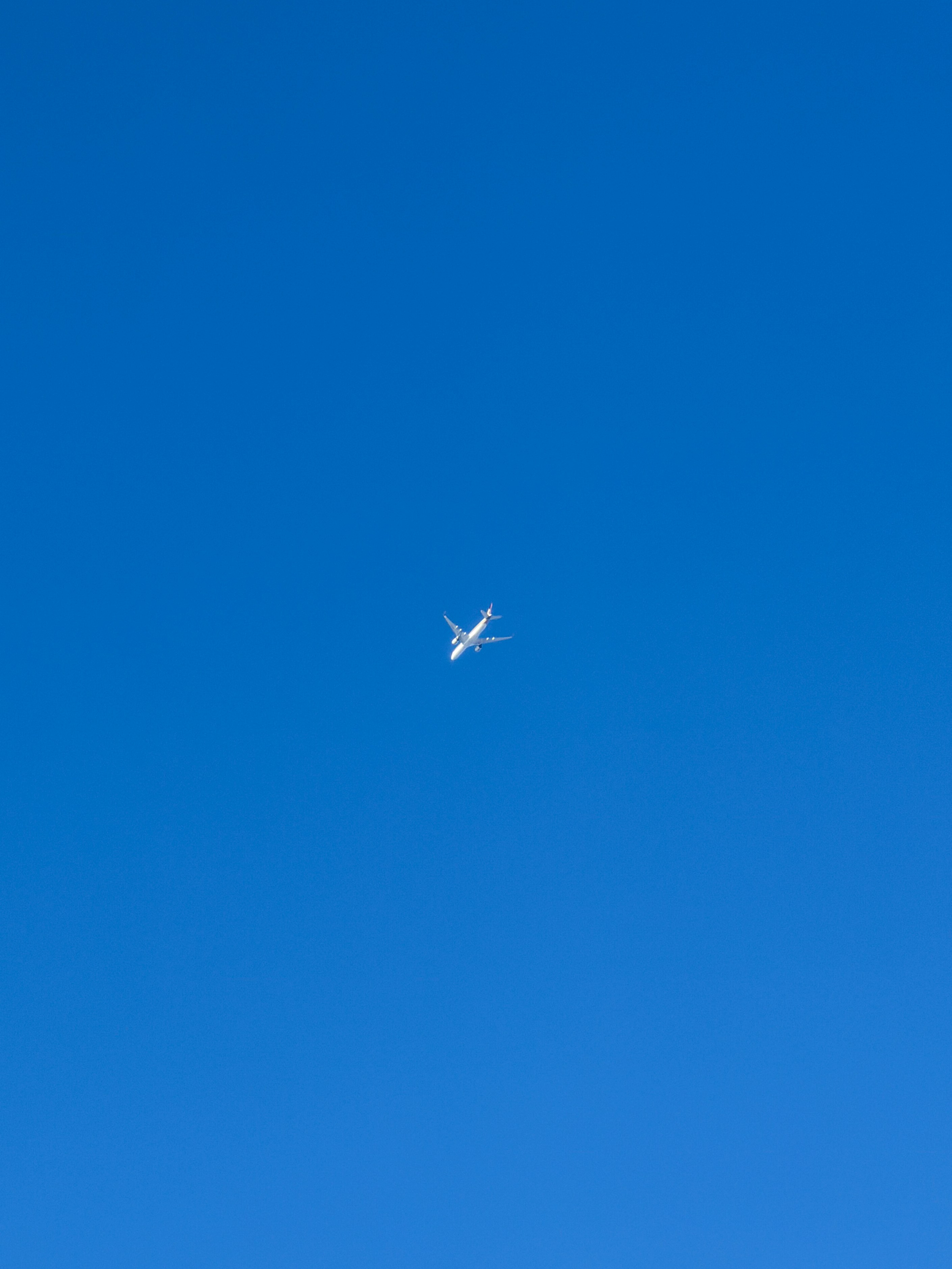 A Lone Jet Traces a Crisp V-Shape Across a Vast Sky
