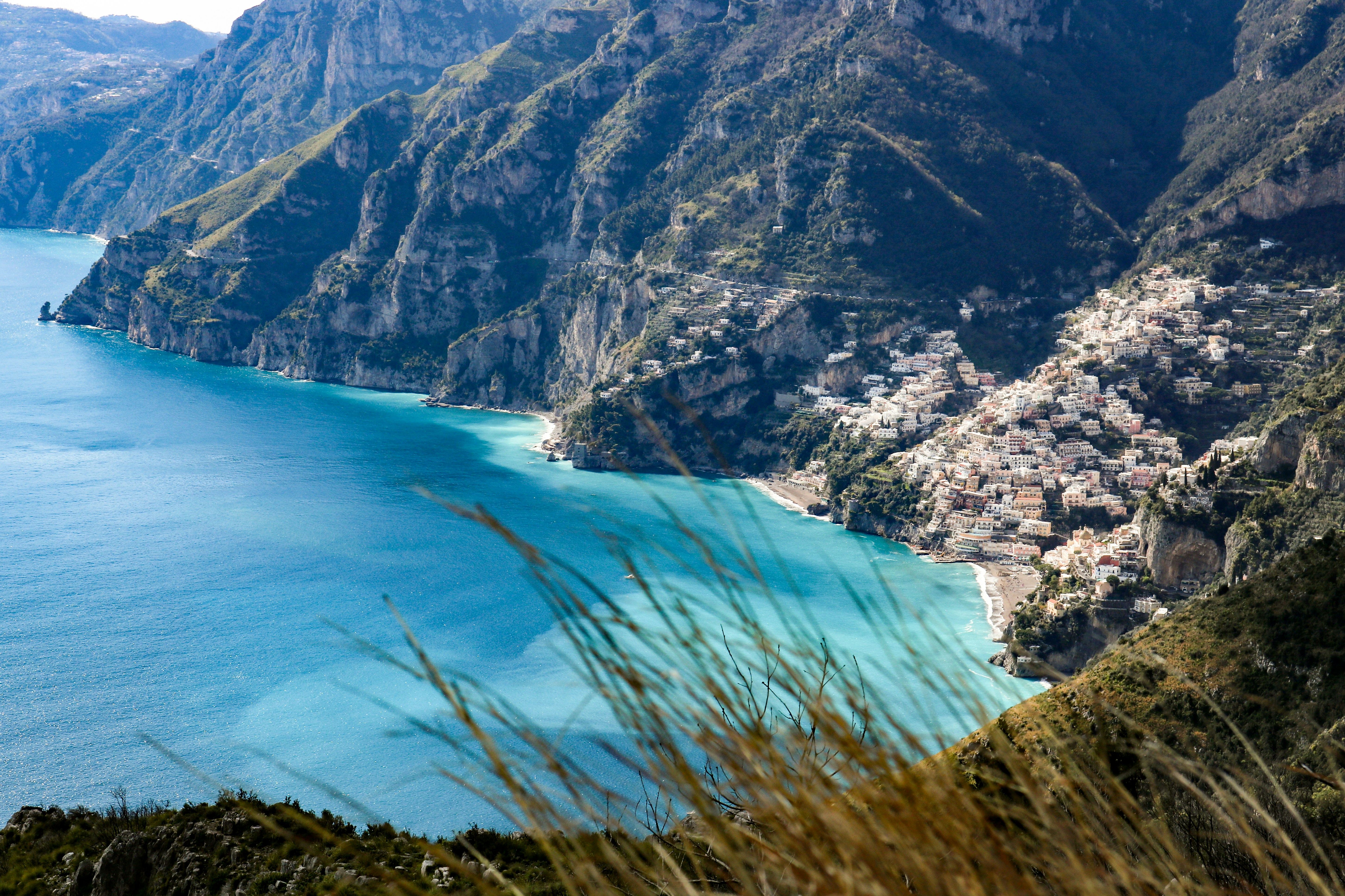 Coastal Cliffside Town Basks in Turquoise Sea Light